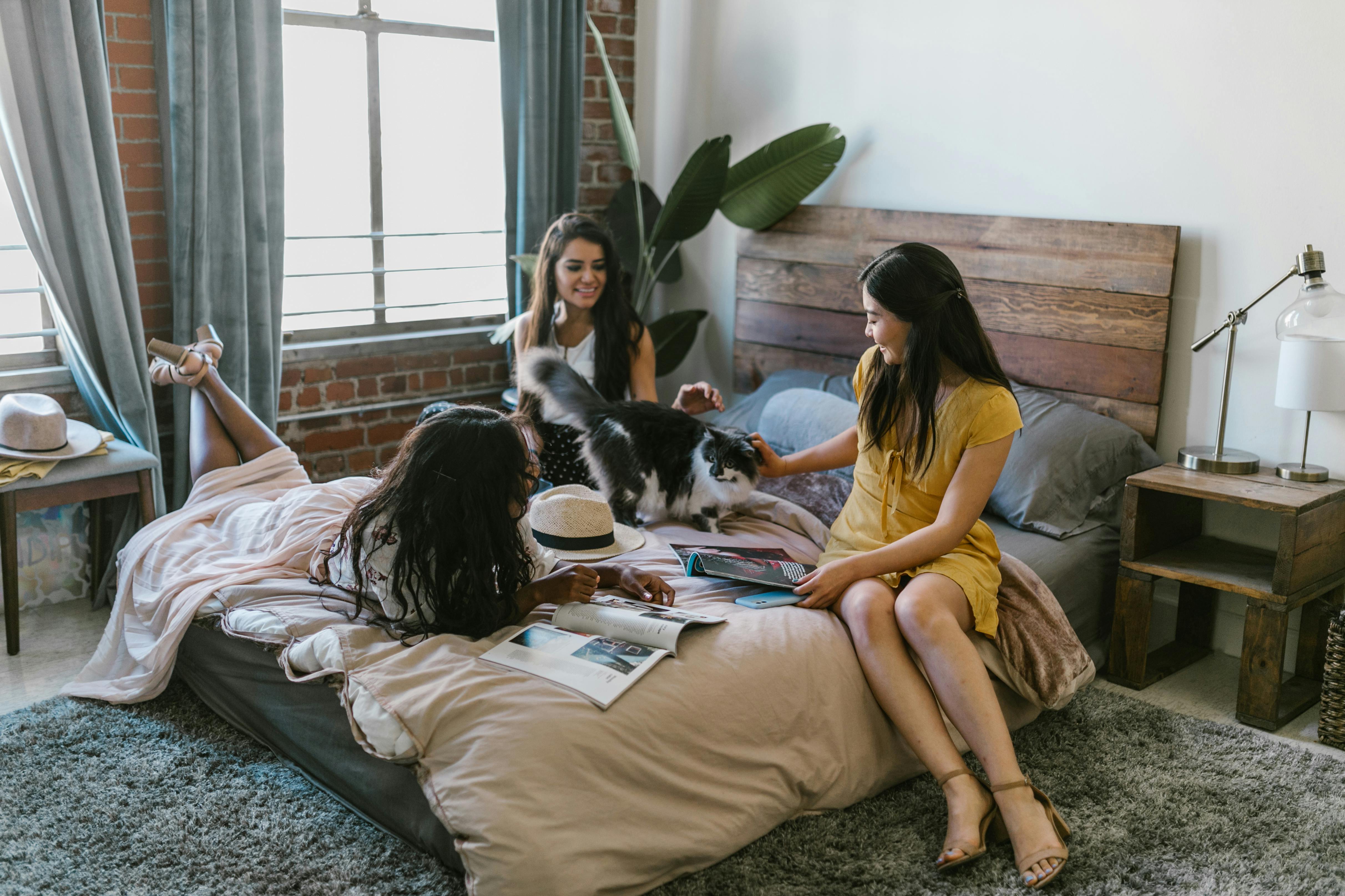 Friends in Bedroom with Cat · Free Stock Photo