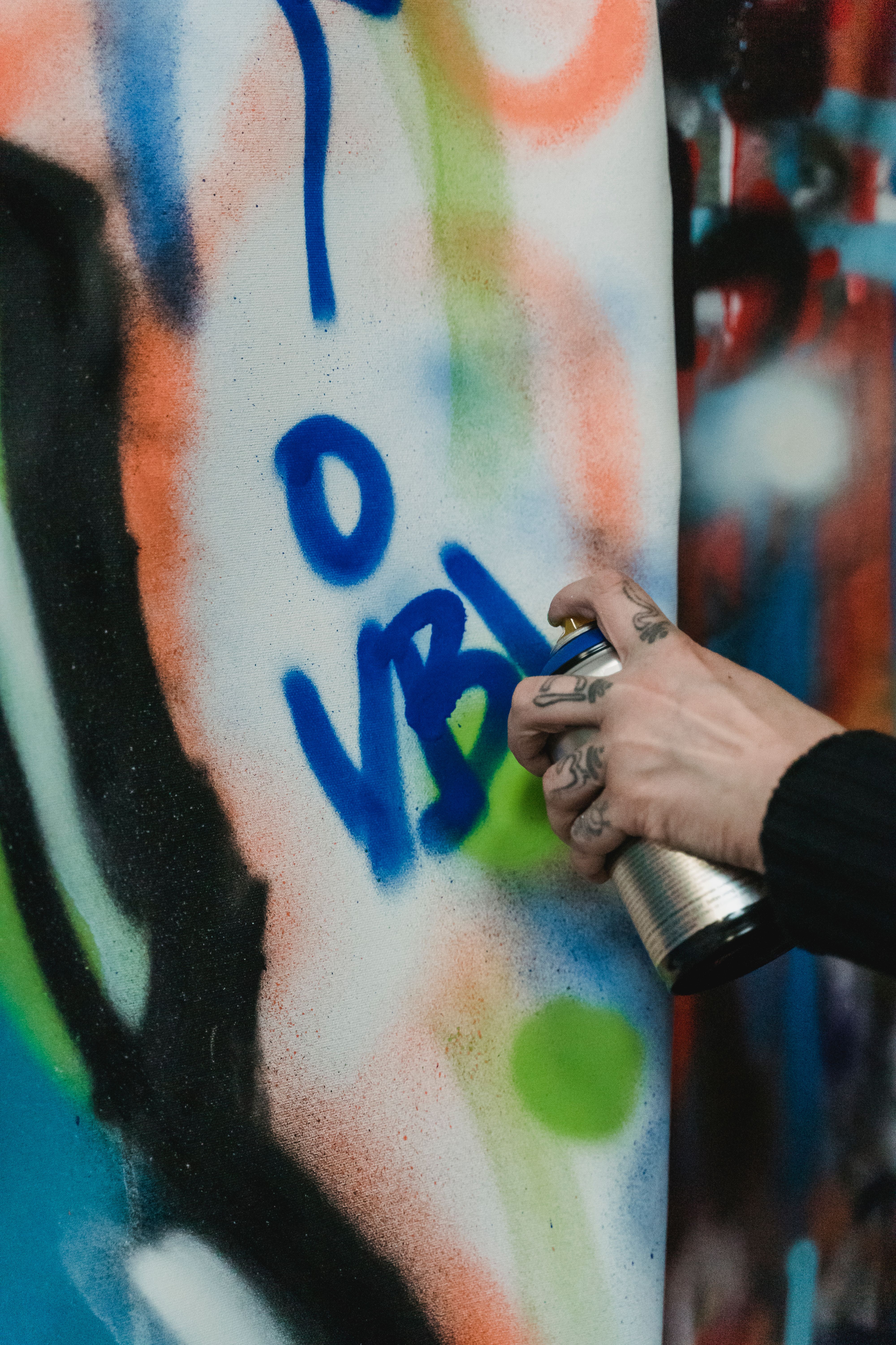 A Person Holding a Spray Paint · Free Stock Photo