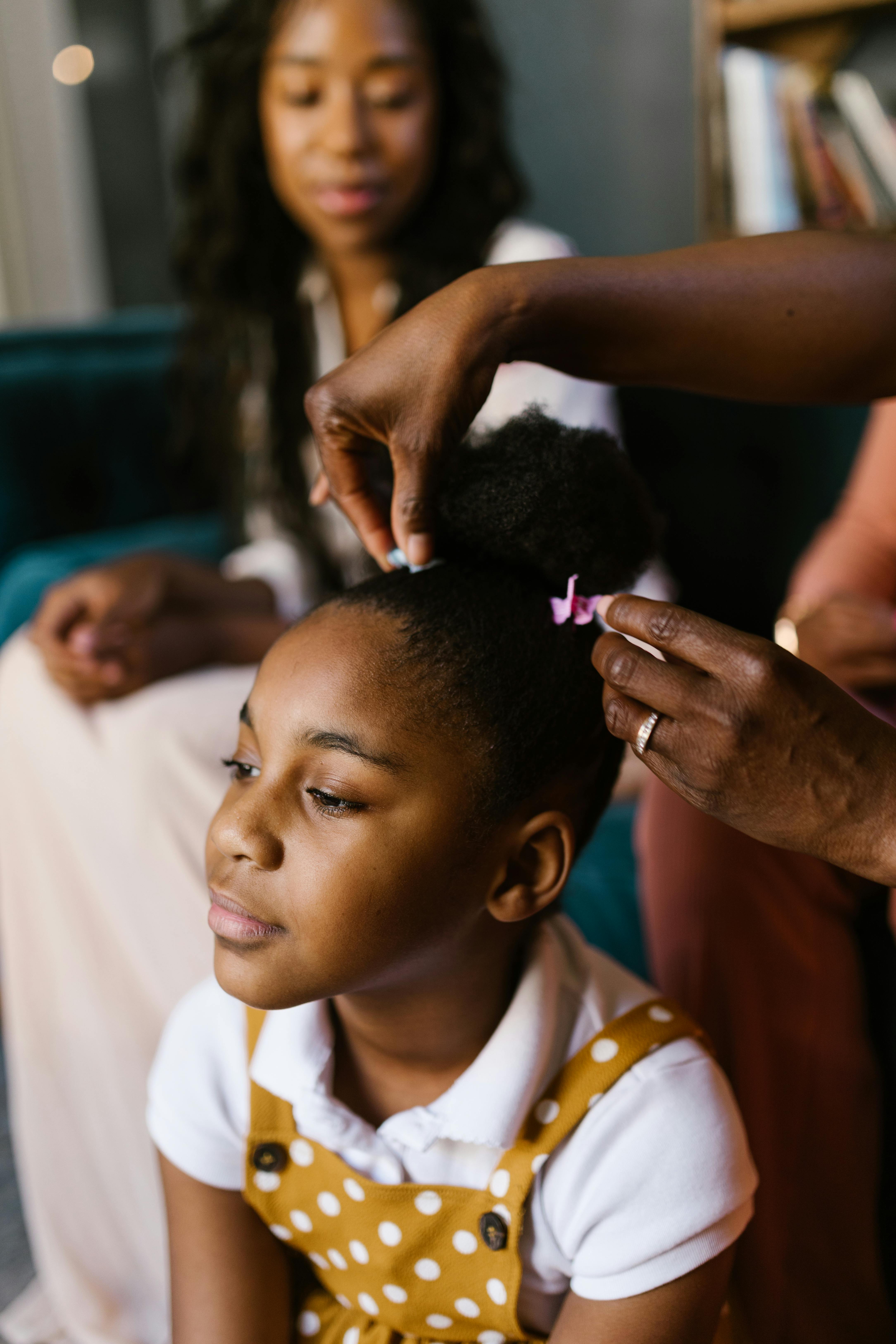 Person Fixing the Hair of a Girl · Free Stock Photo