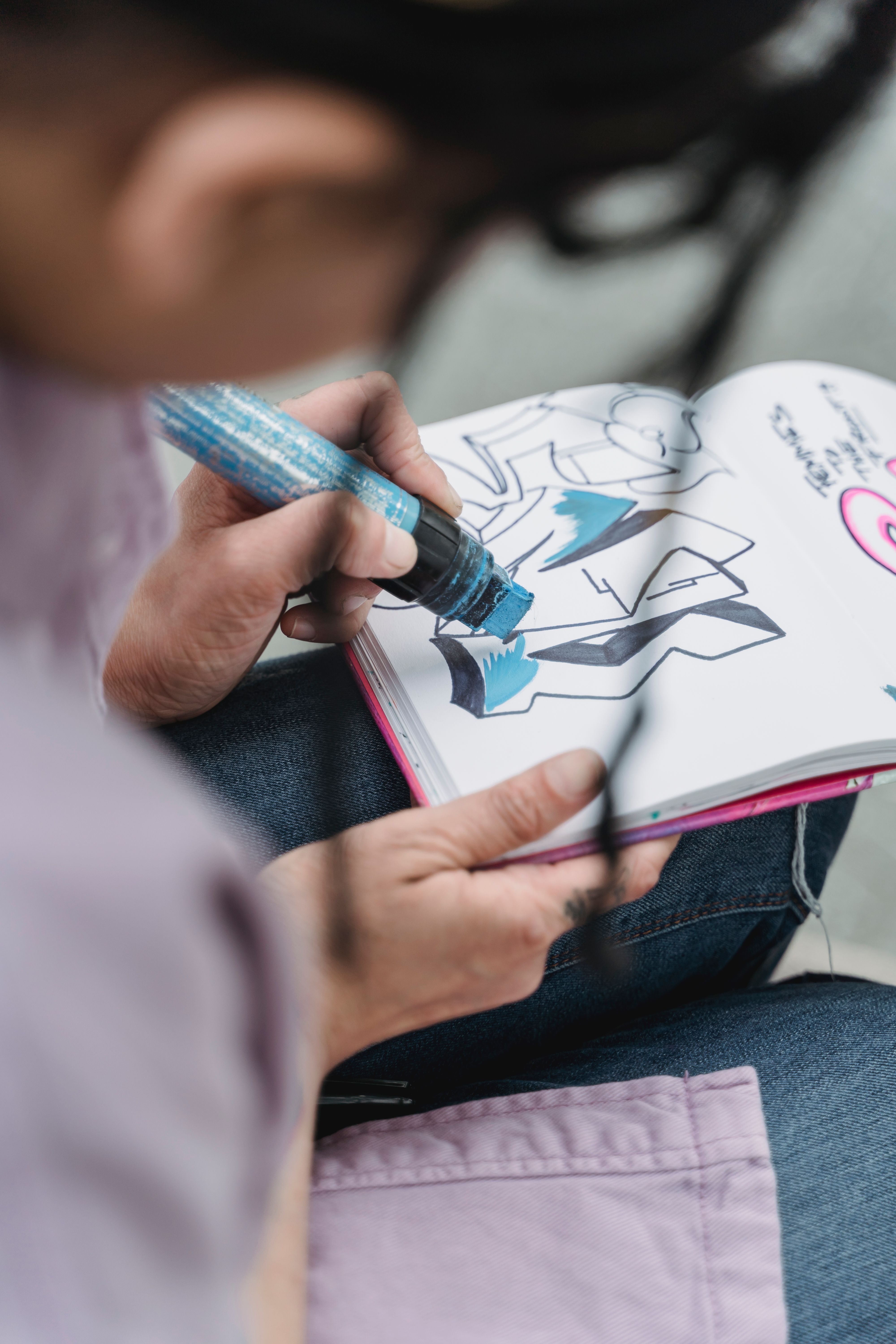 Woman Drawing in a Notebook · Free Stock Photo