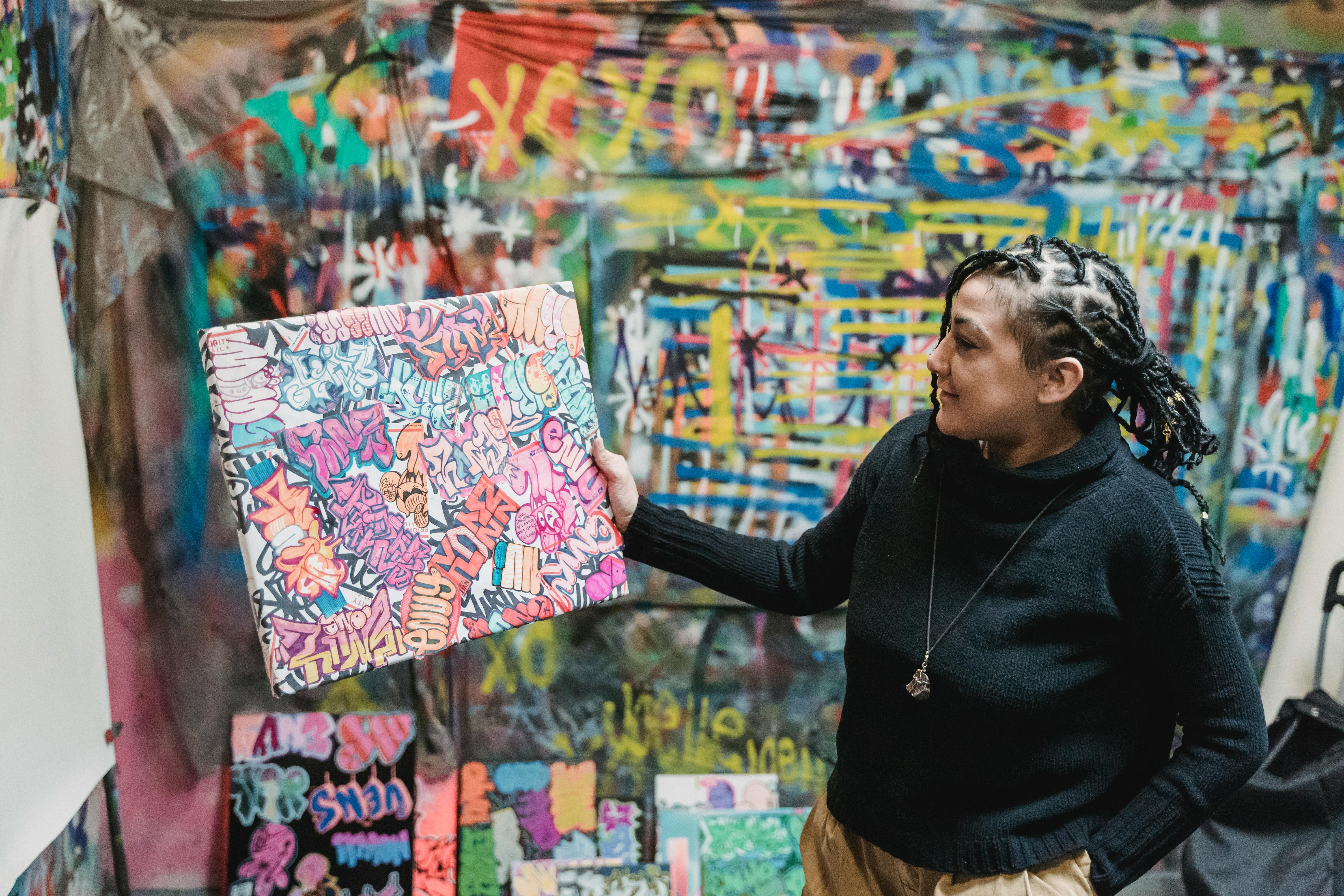 Woman Showing Graffiti Painting · Free Stock Photo