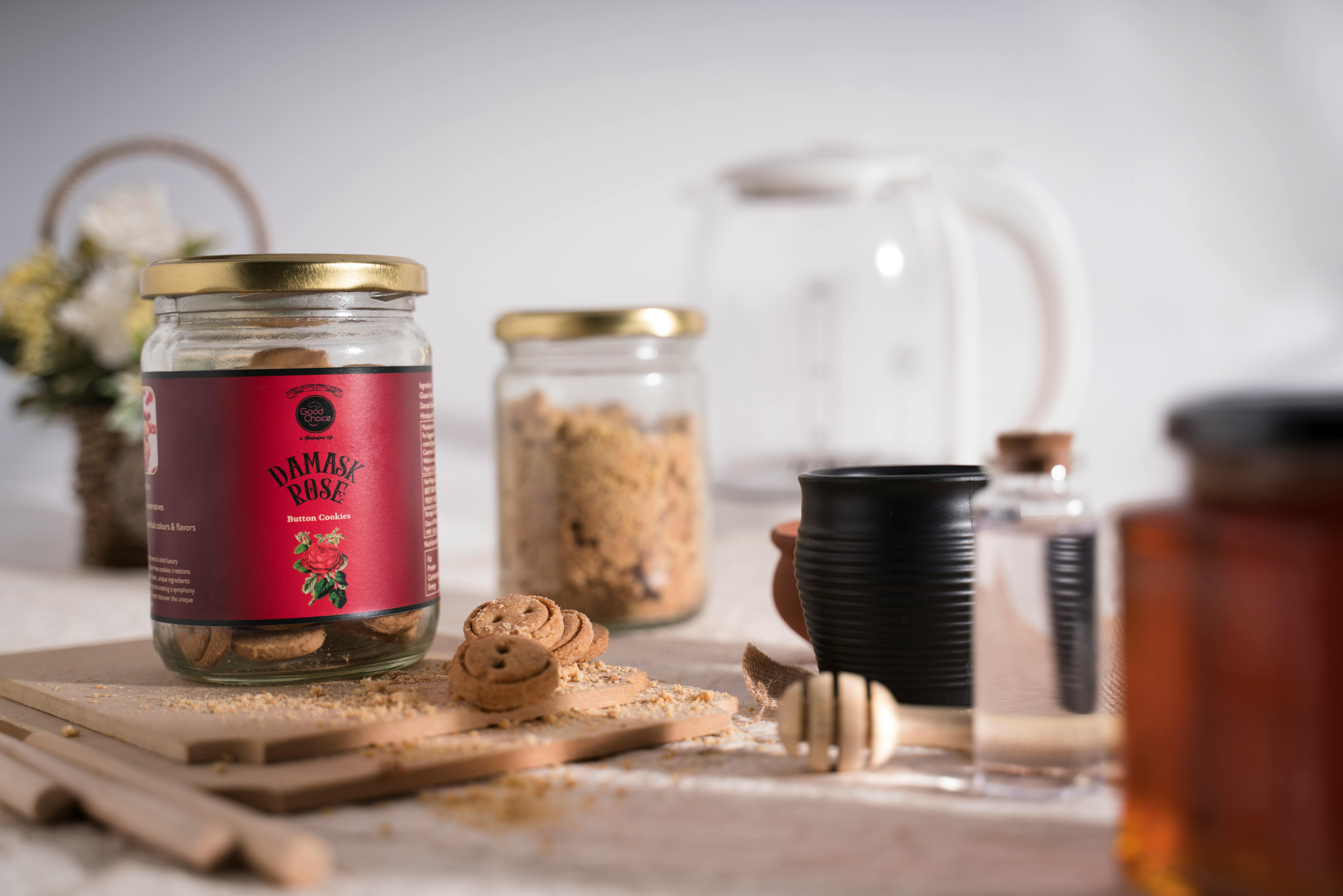 Glass Containers with Cookies on White Surface · Free Stock Photo