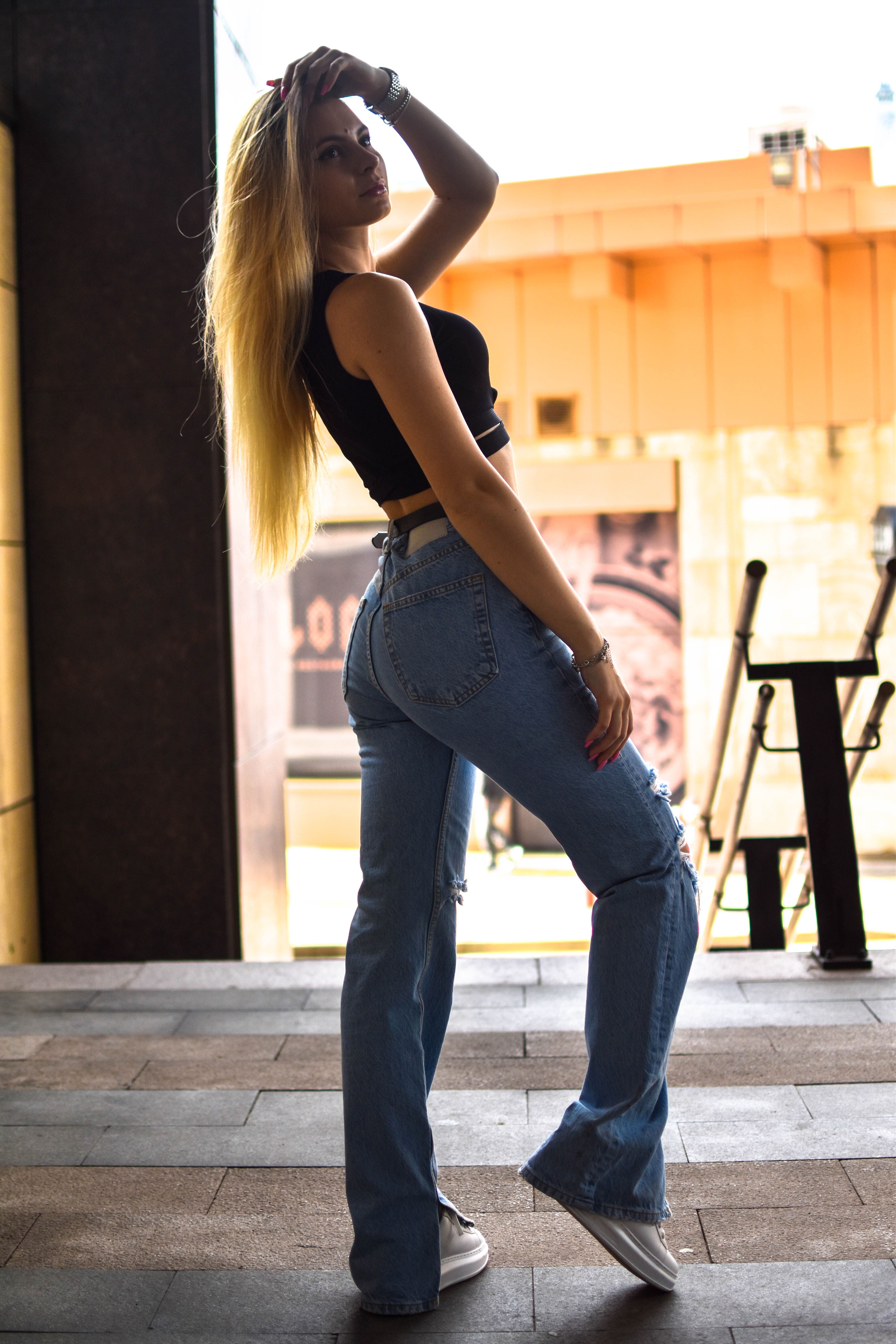 A Scared Woman Crouching while Her Hands are on Her Head · Free Stock Photo