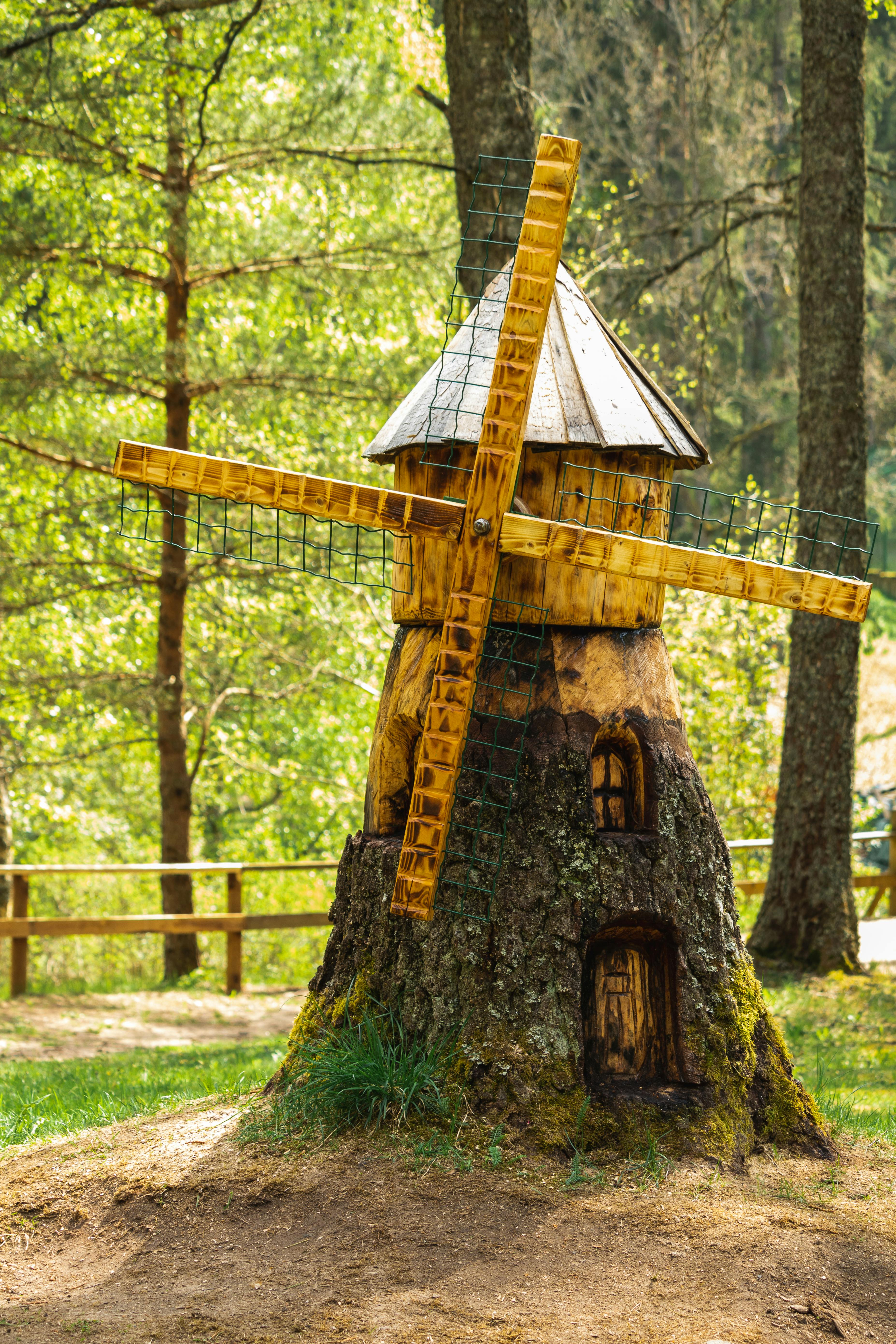 A Tree Stump Carved into a Windmill · Free Stock Photo