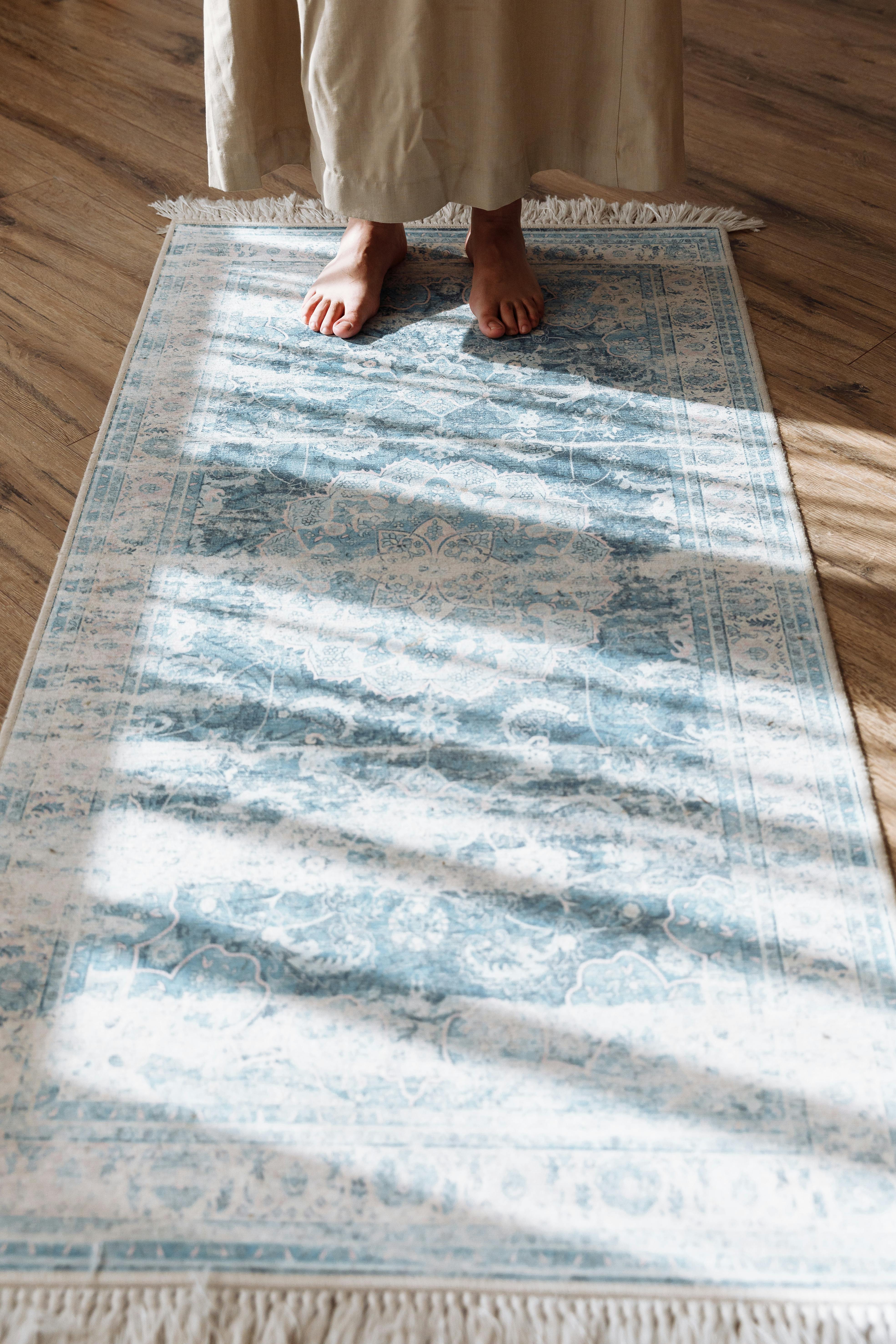 Person standing on a Prayer Rug · Free Stock Photo