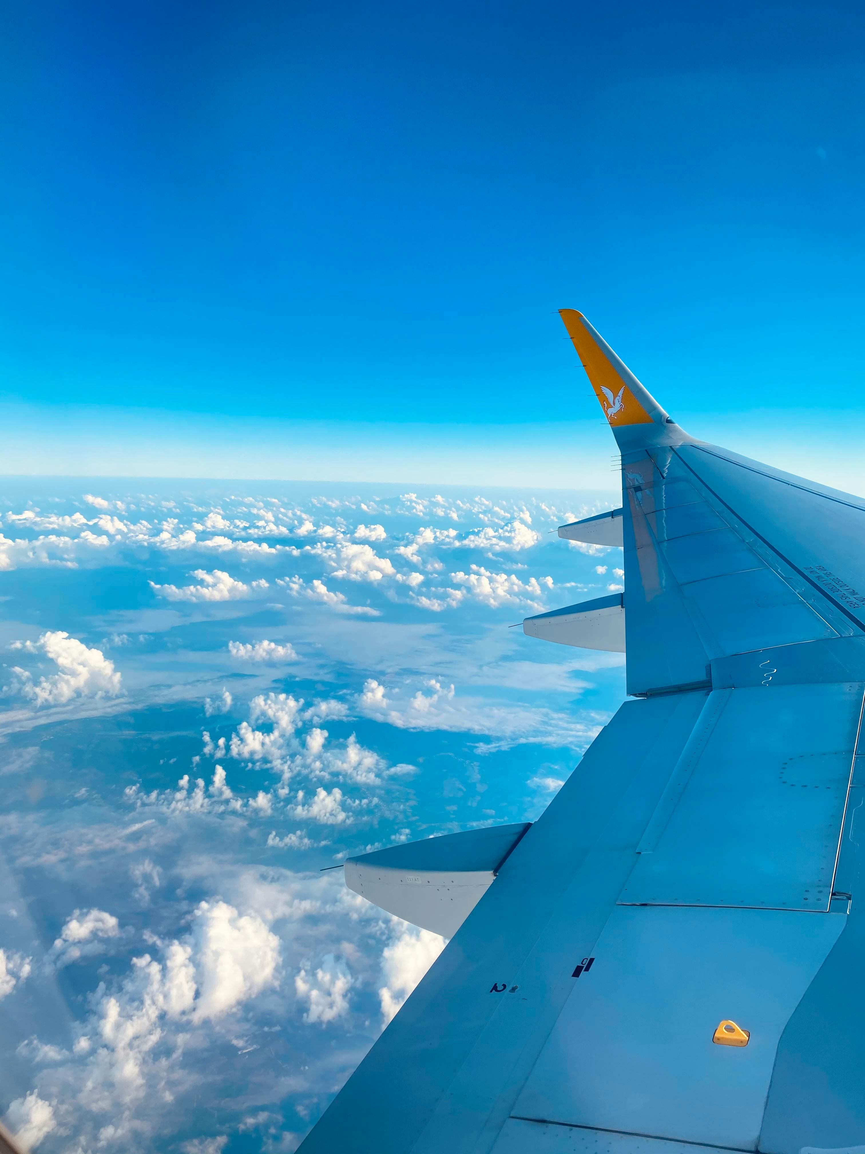 View of airplane wing through plane window · Free Stock Photo