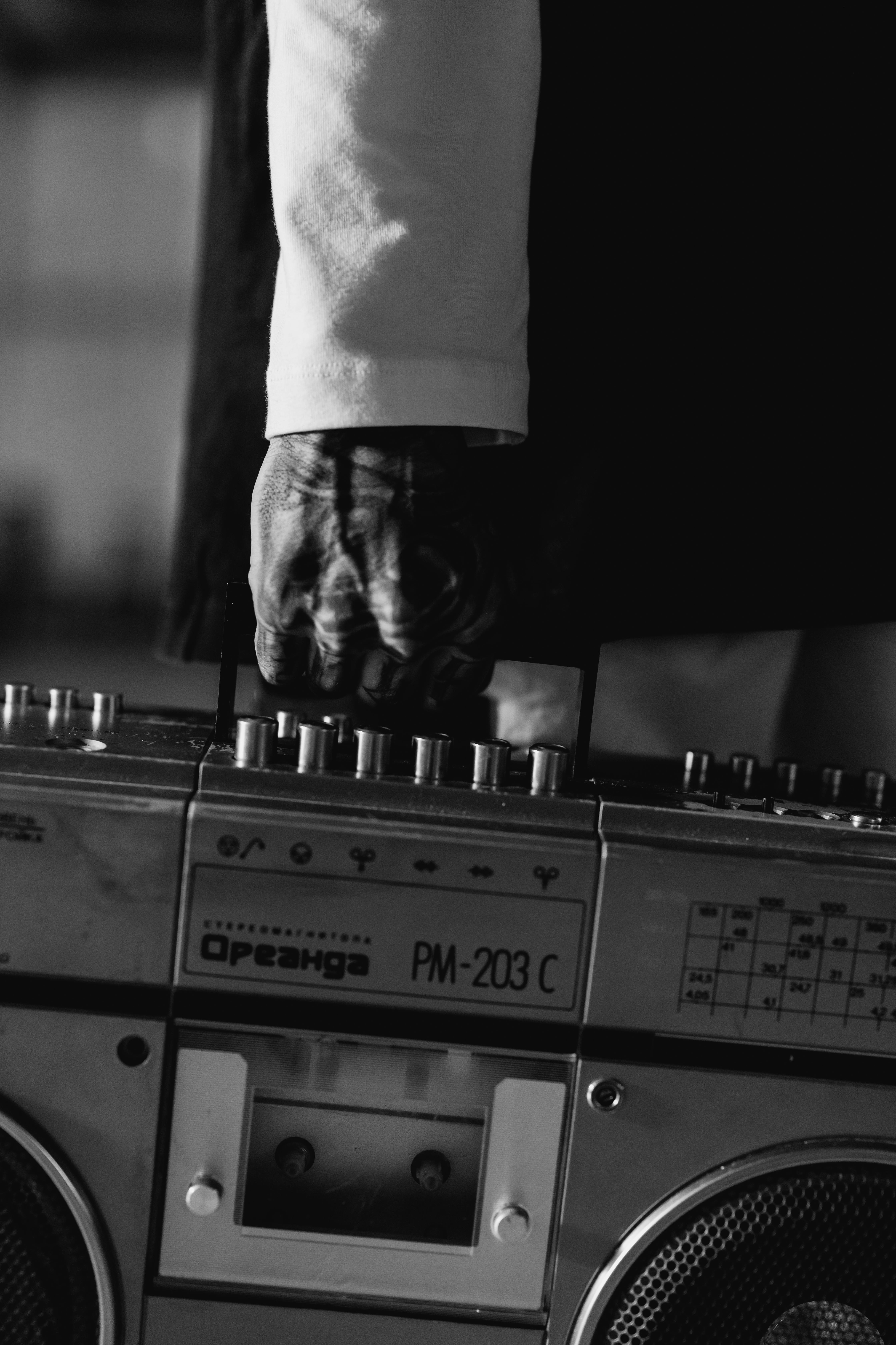 Grayscale Photo of a Person's Hand Carrying a Boombox · Free Stock Photo