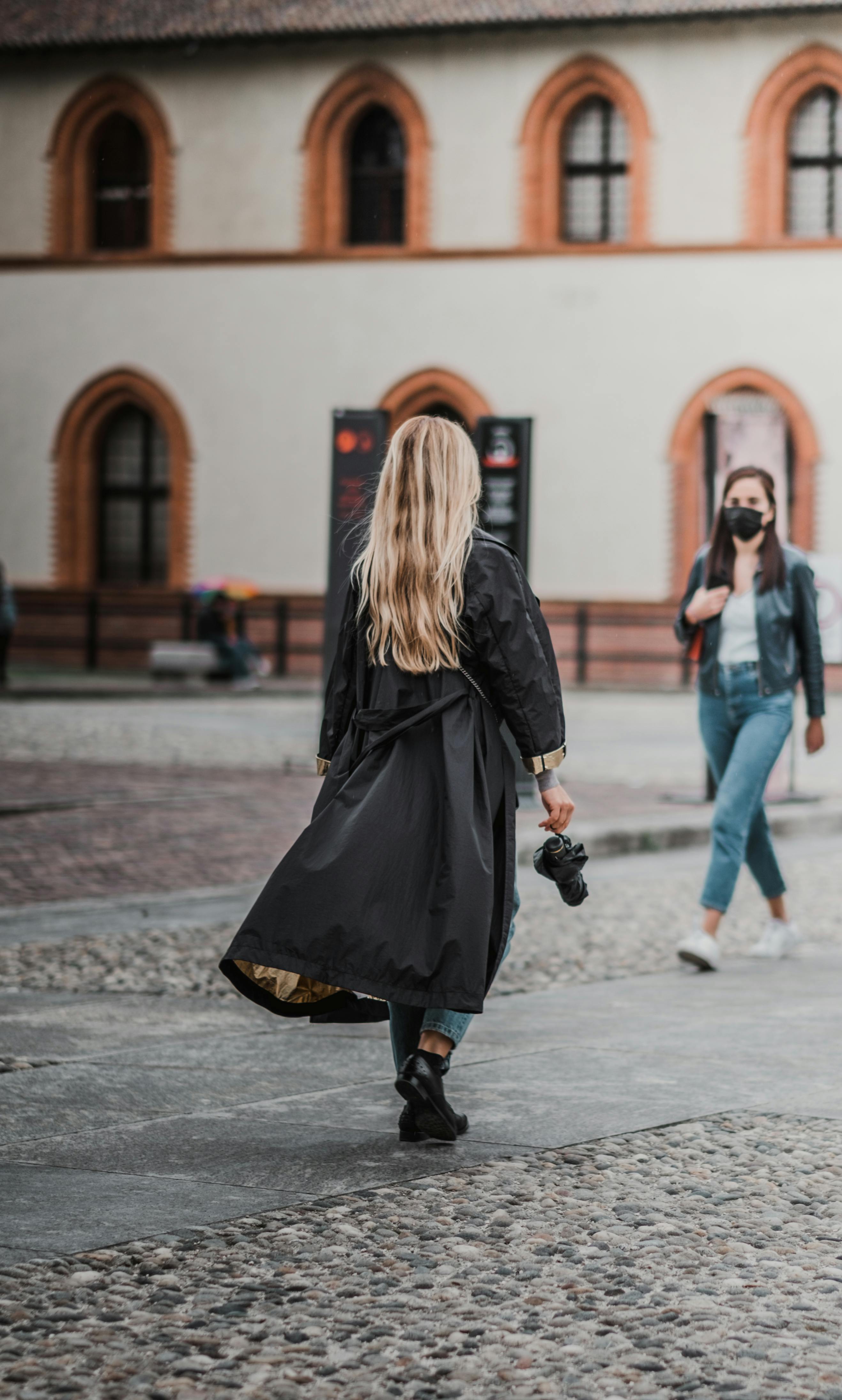Back View of a Woman Wearing Trench Coat Walking · Free Stock Photo
