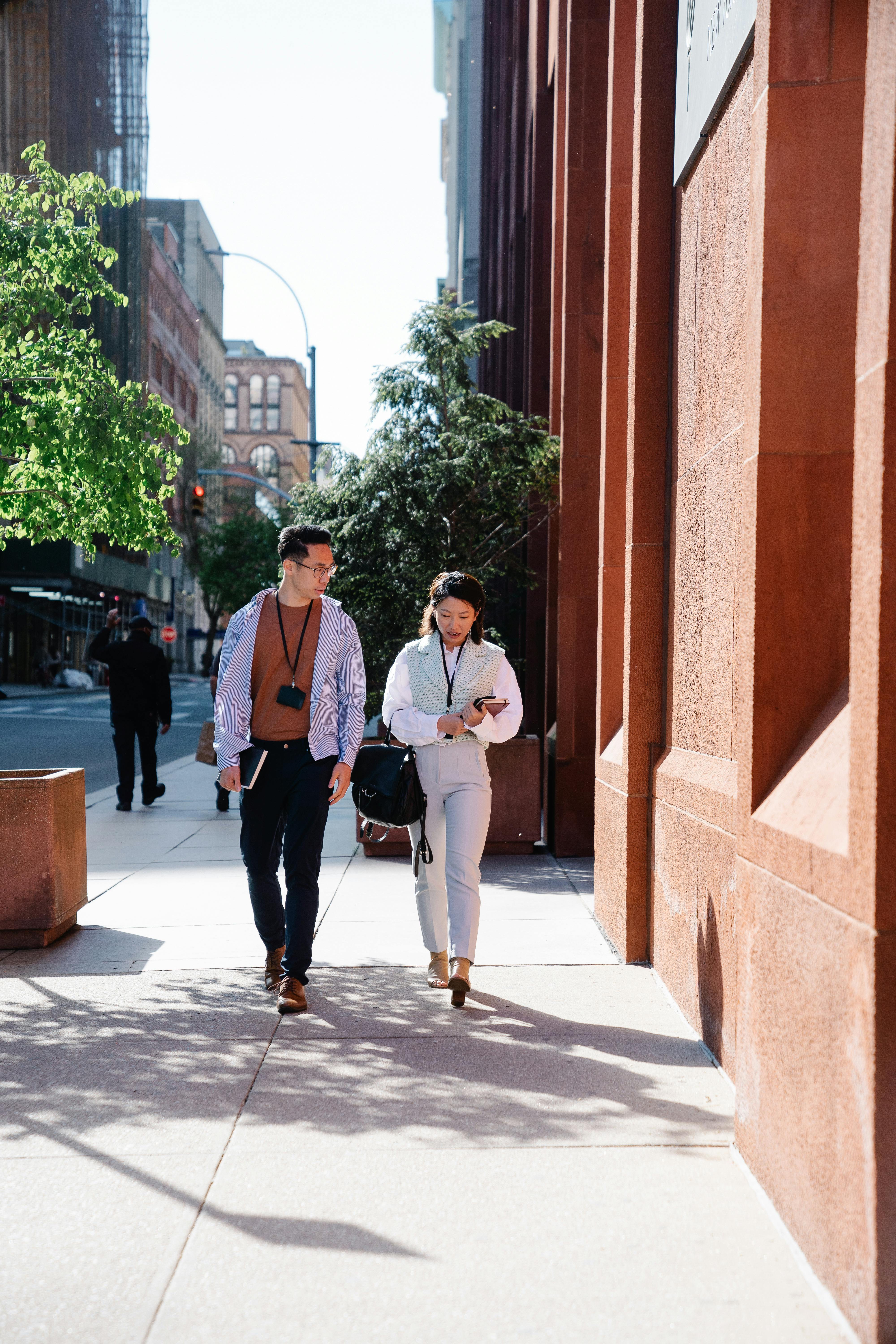 Pedestrians Walking along Sidewalk · Free Stock Photo