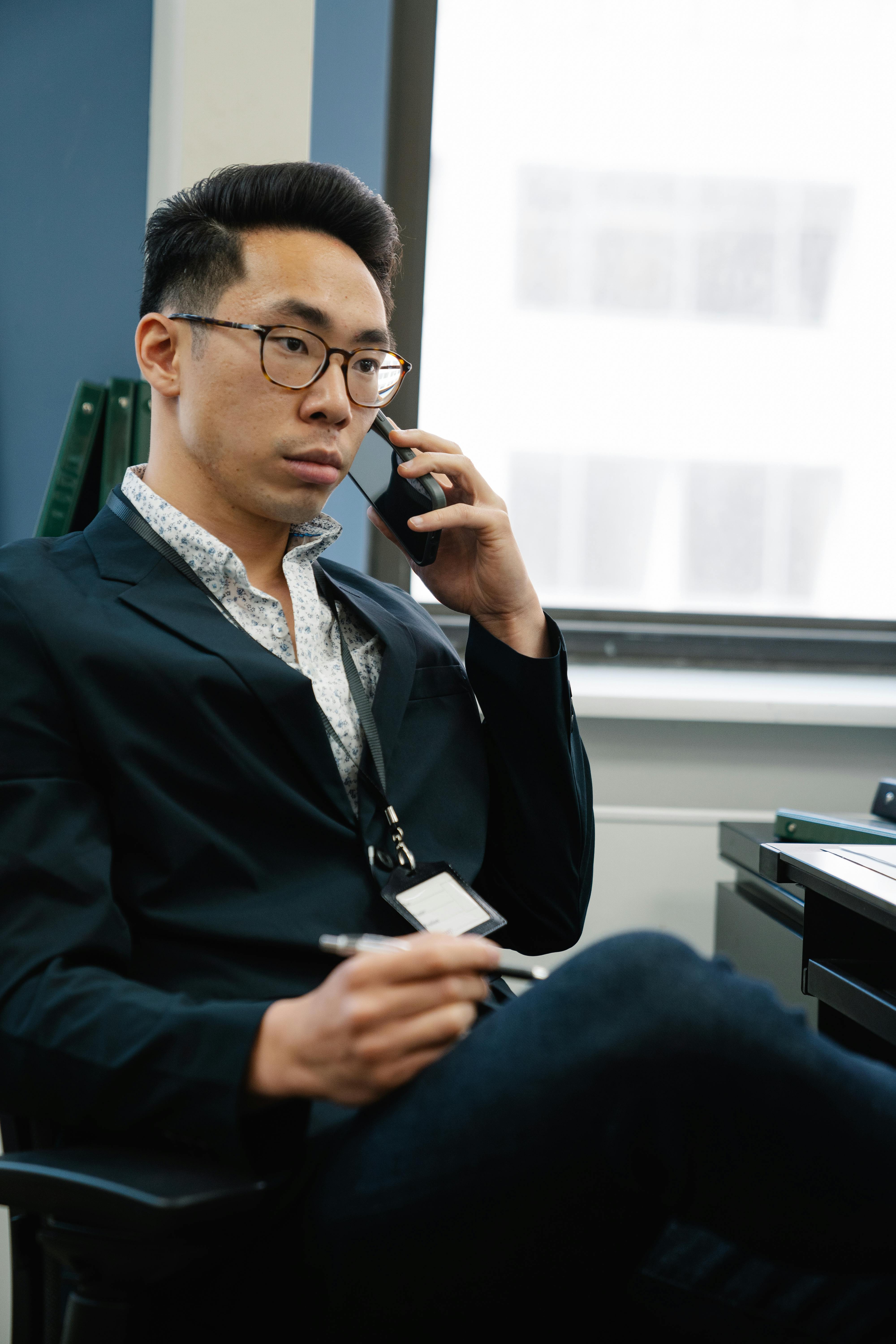 Close up of a Man Using Phone in an Office · Free Stock Photo