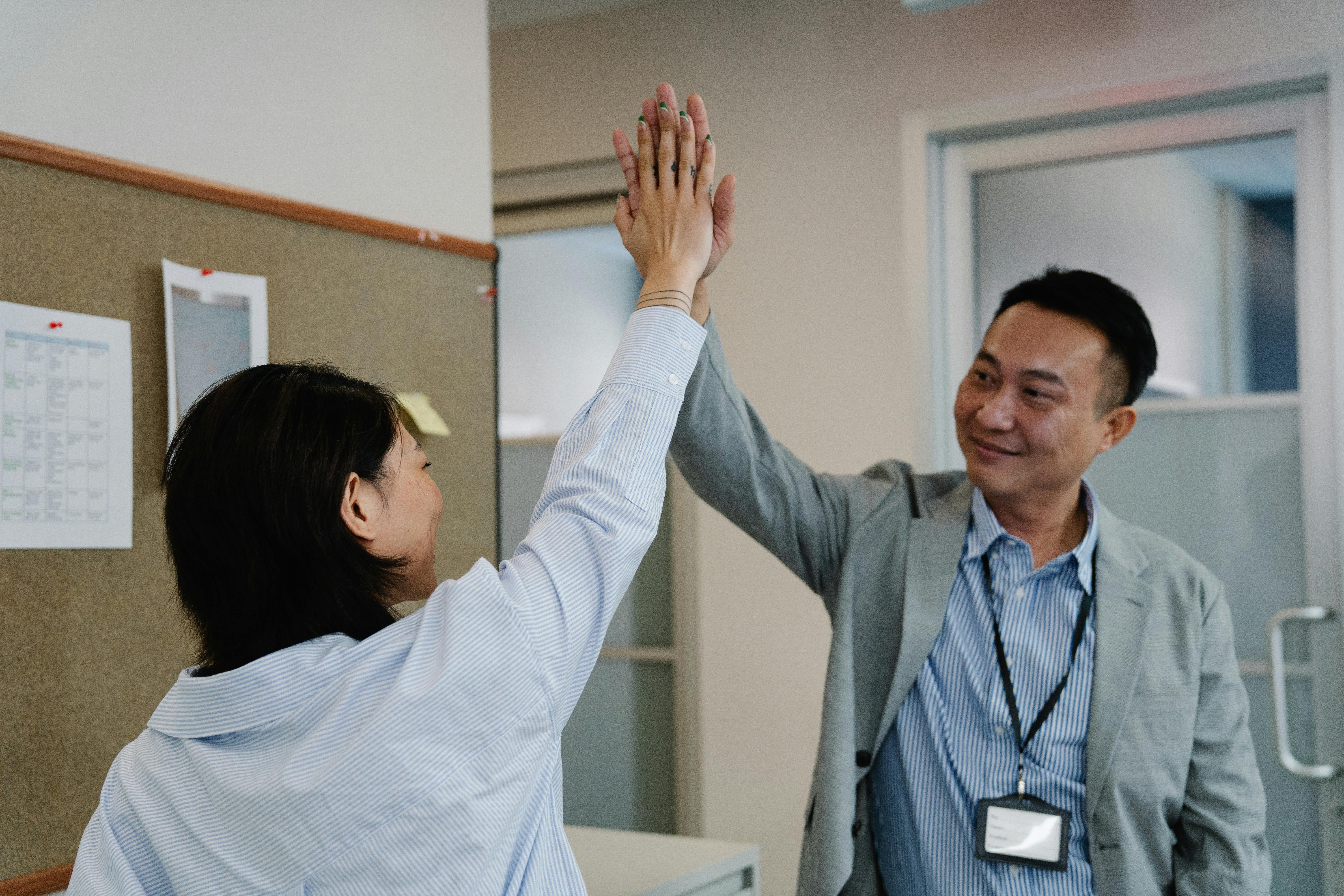 Man and Woman Doing a High Five · Free Stock Photo