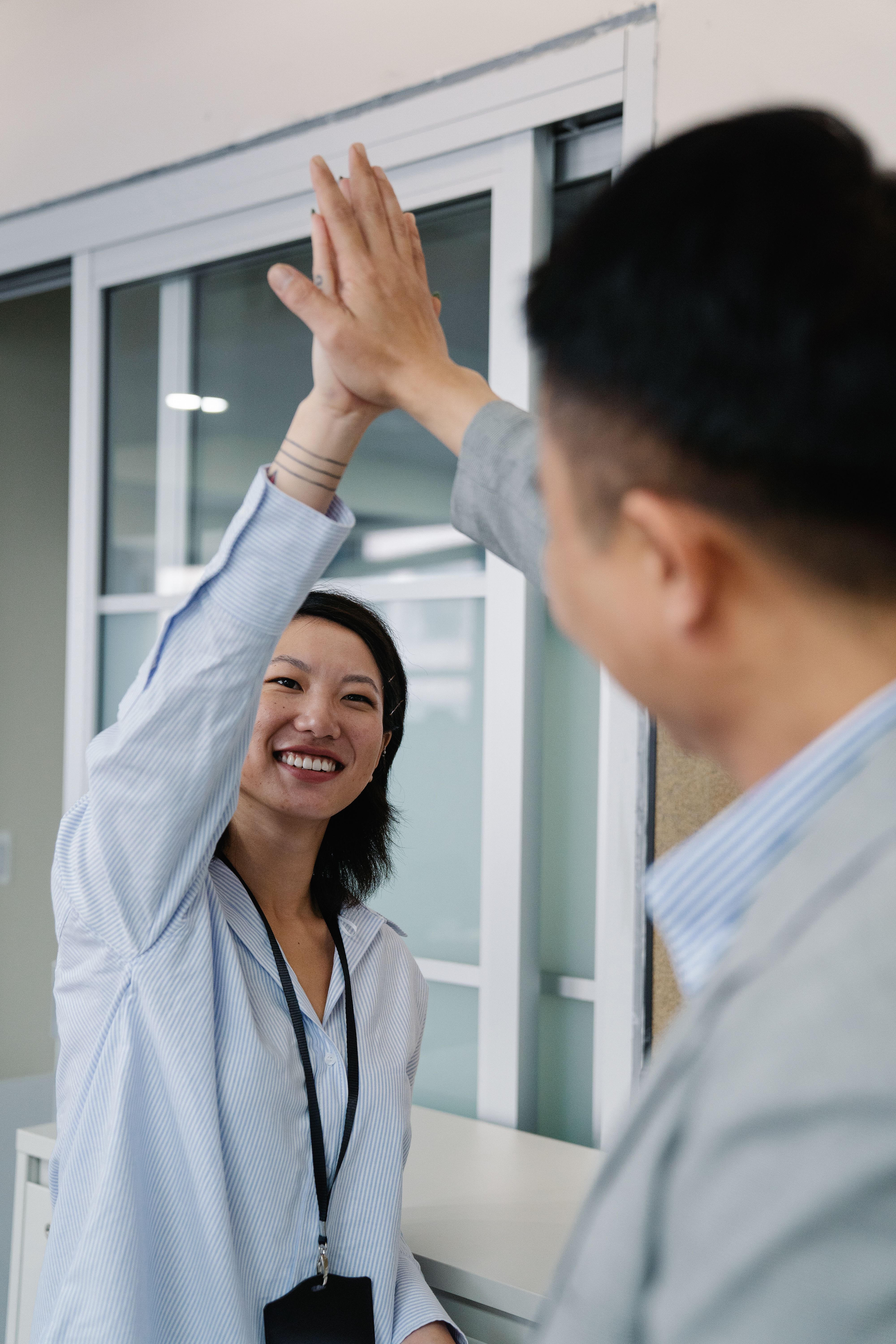 A Woman and Man doing High Five · Free Stock Photo