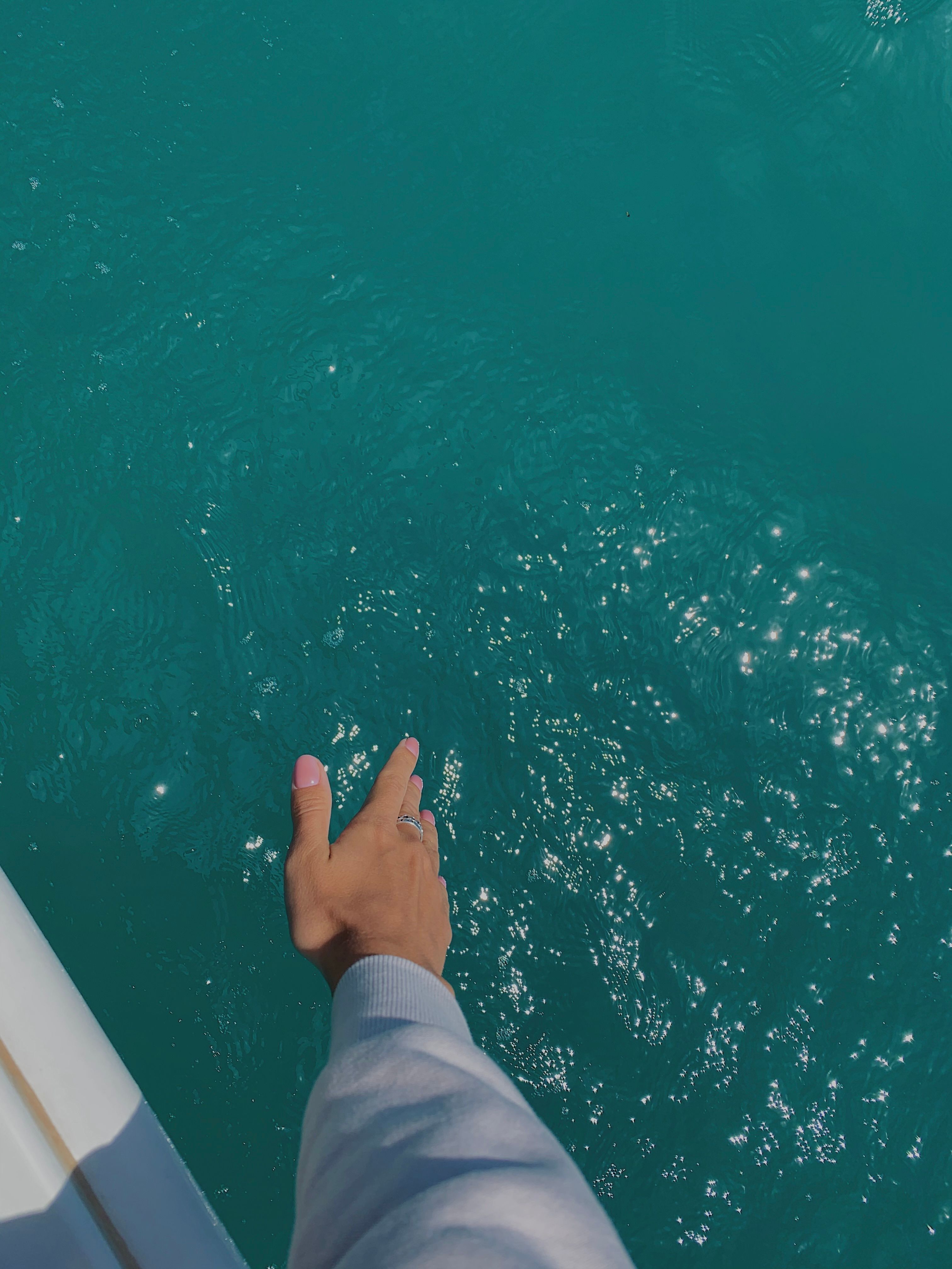 Person Touching a Body of Water · Free Stock Photo