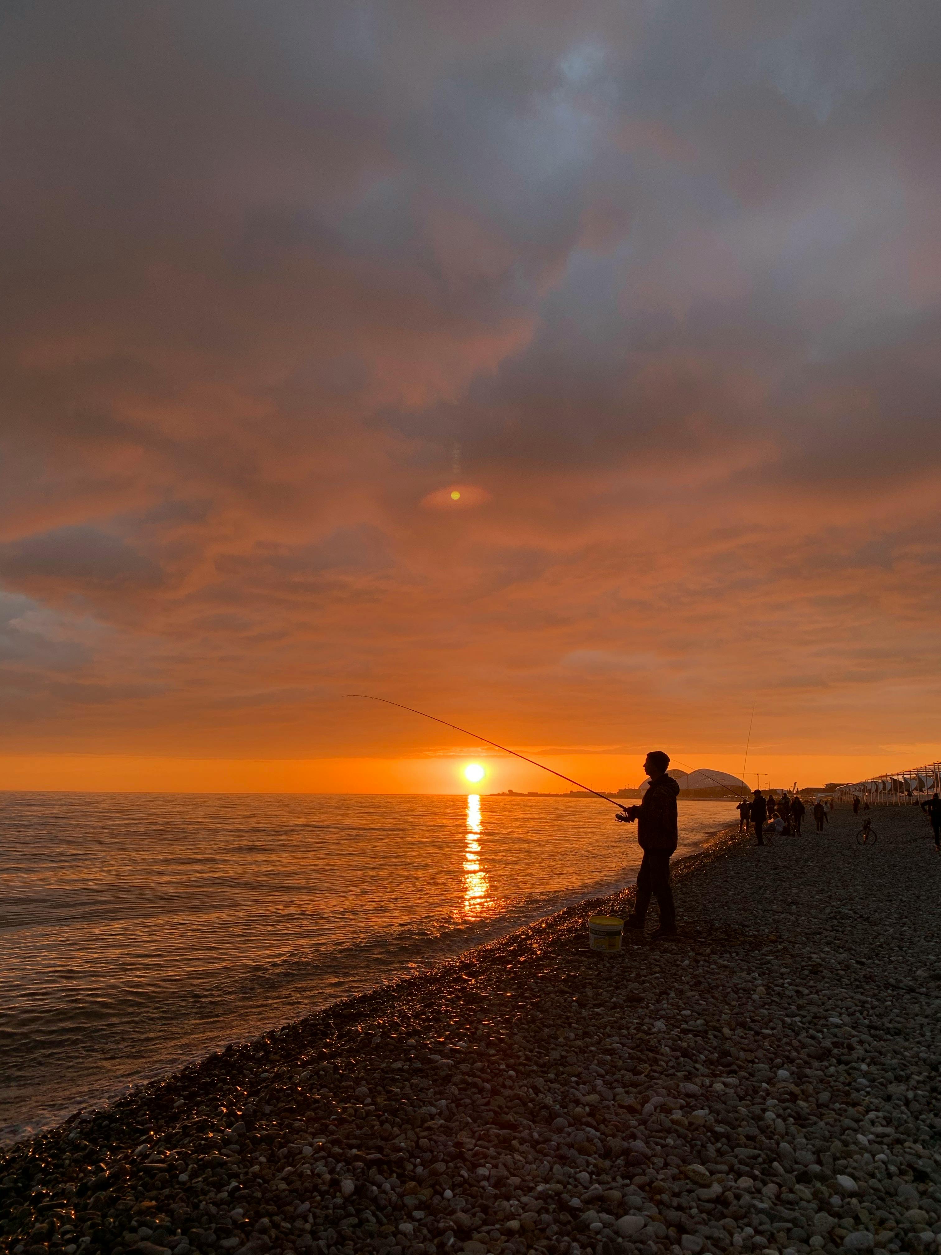 Person Fishing During Golden Hour · Free Stock Photo
