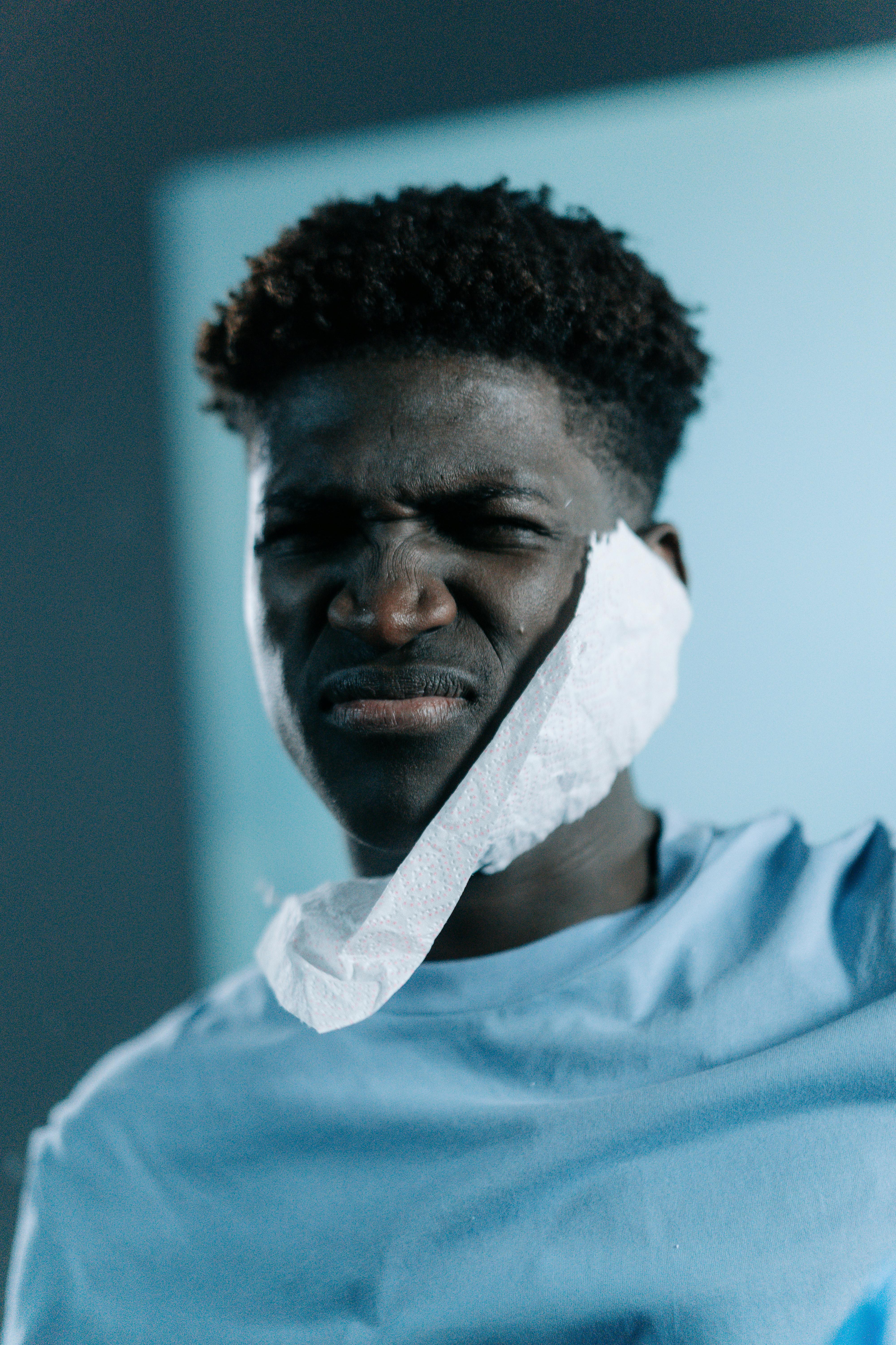 Portrait of a Man with Tissue Paper on His Face · Free Stock Photo