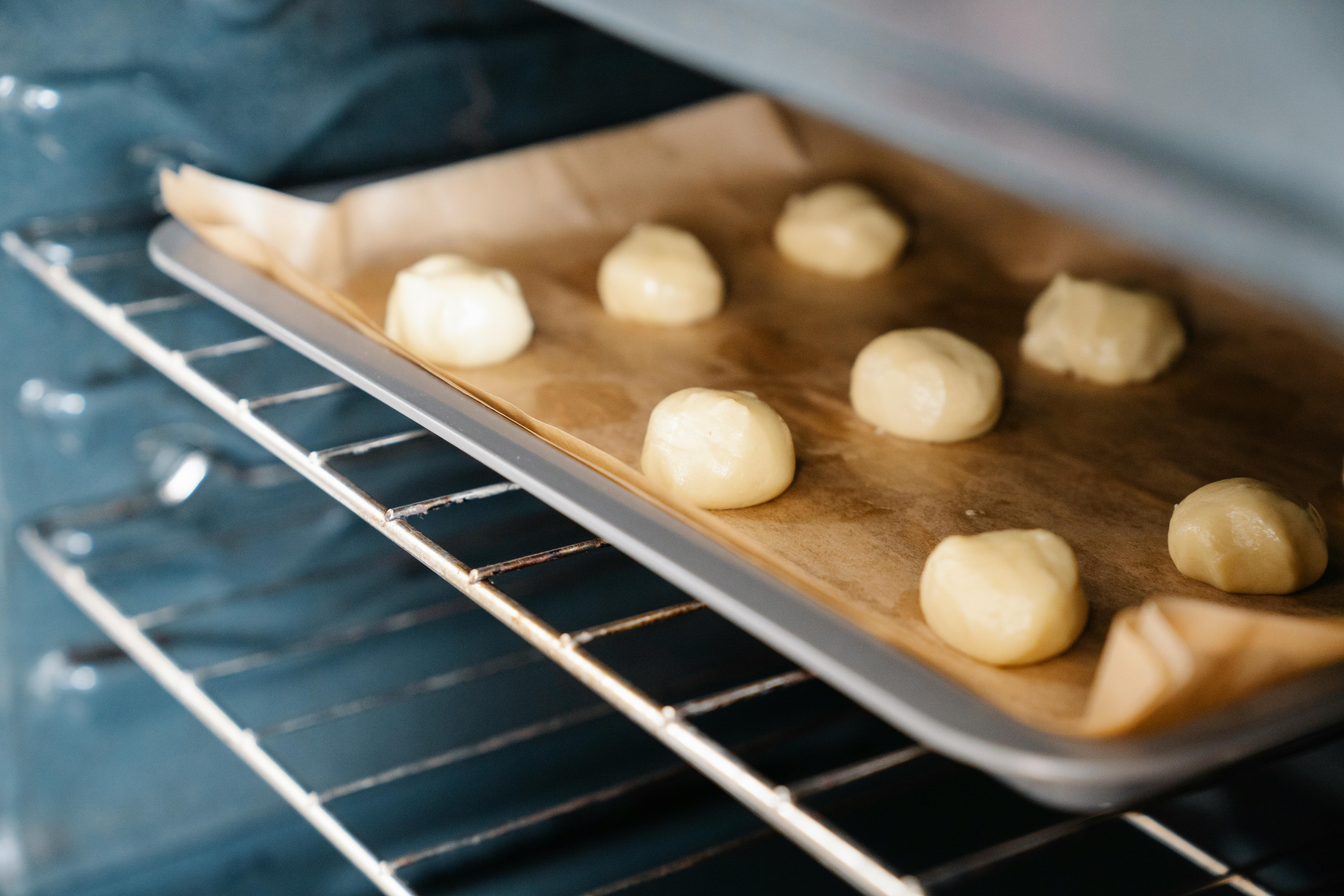 Rounded Dough on Baking Tray Place in an Oven · Free Stock Photo