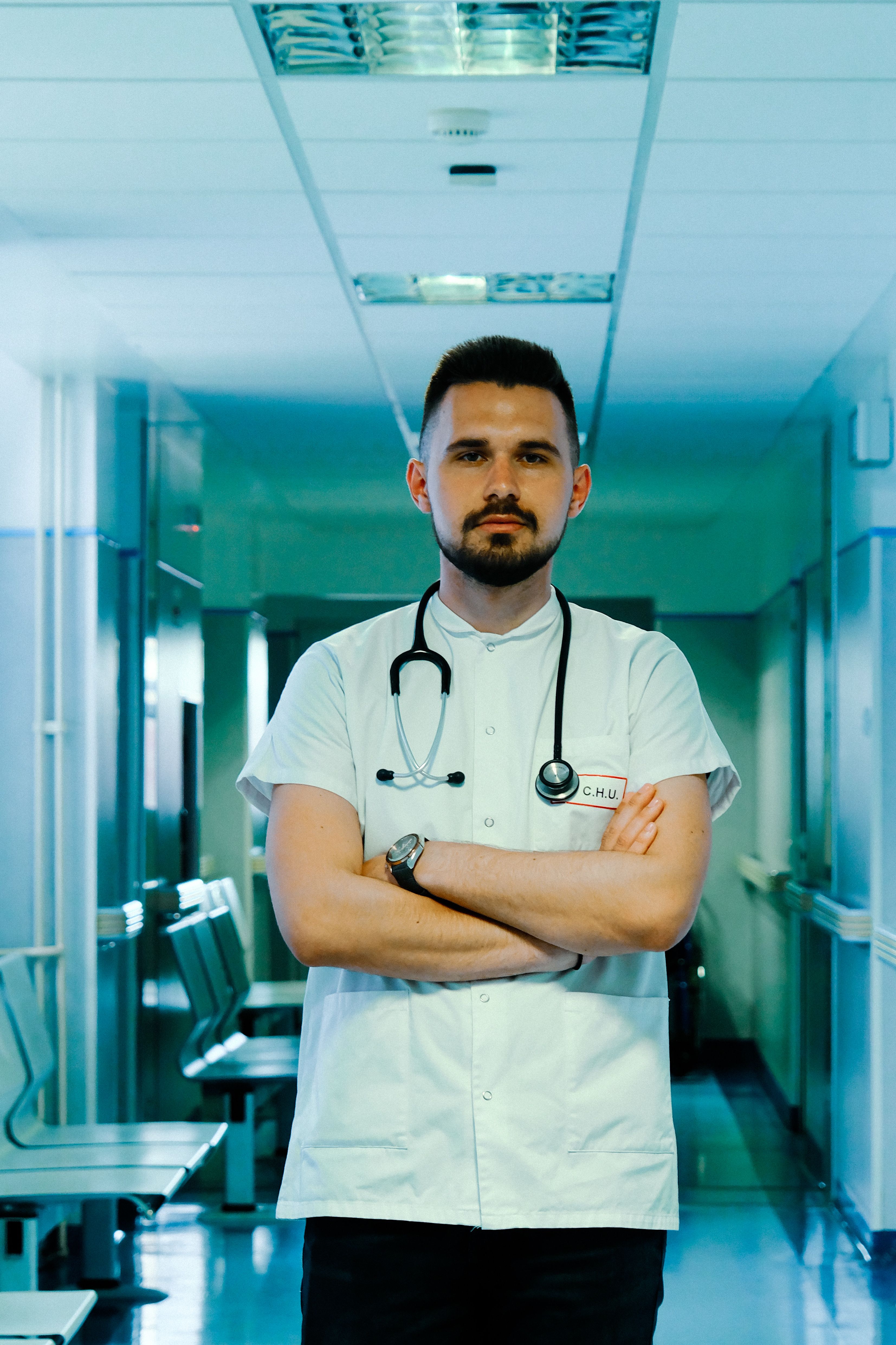 Man in White Uniform Standing on the Hallway · Free Stock Photo