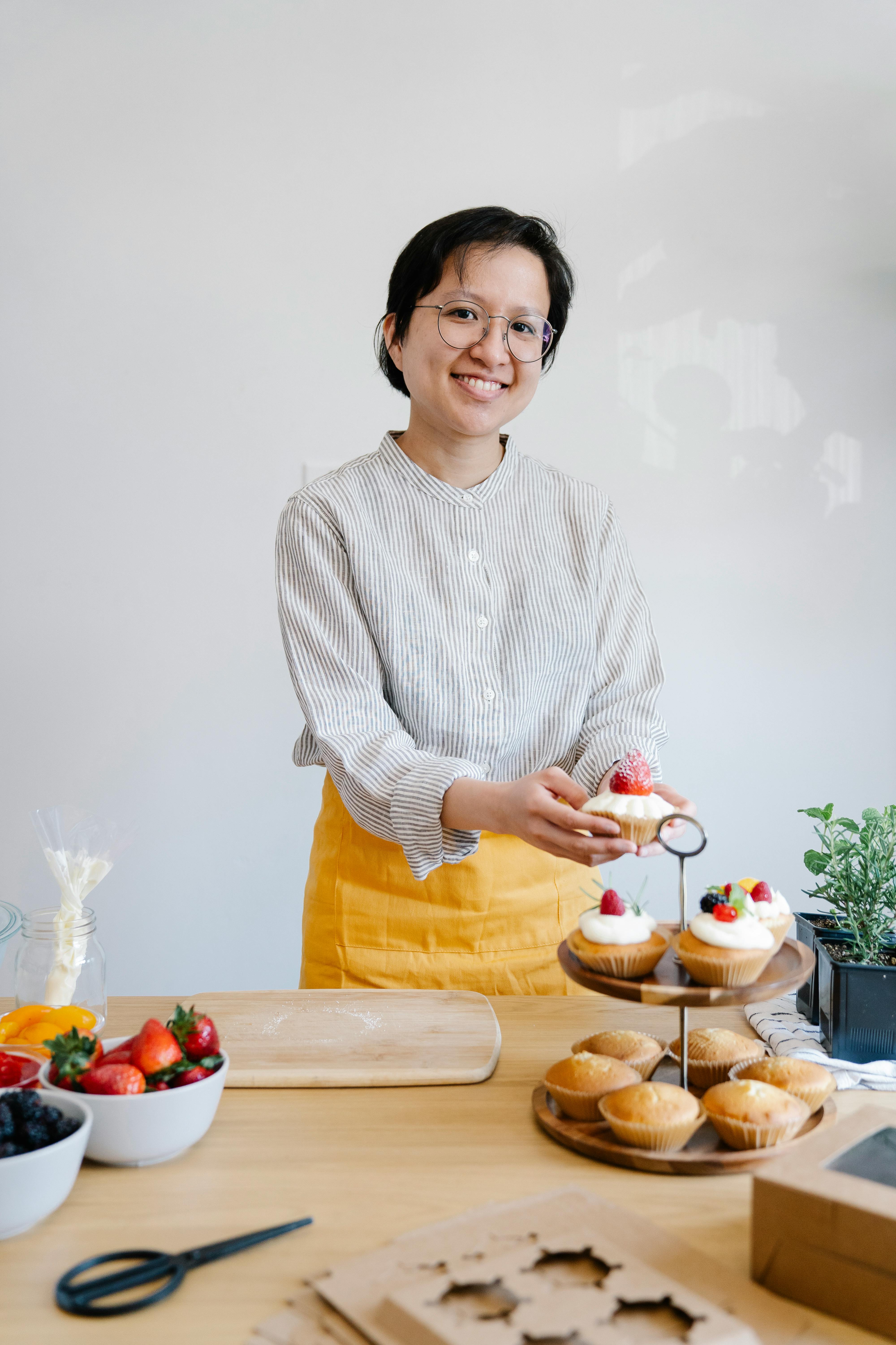 Portrait of Woman with Cupcakes · Free Stock Photo