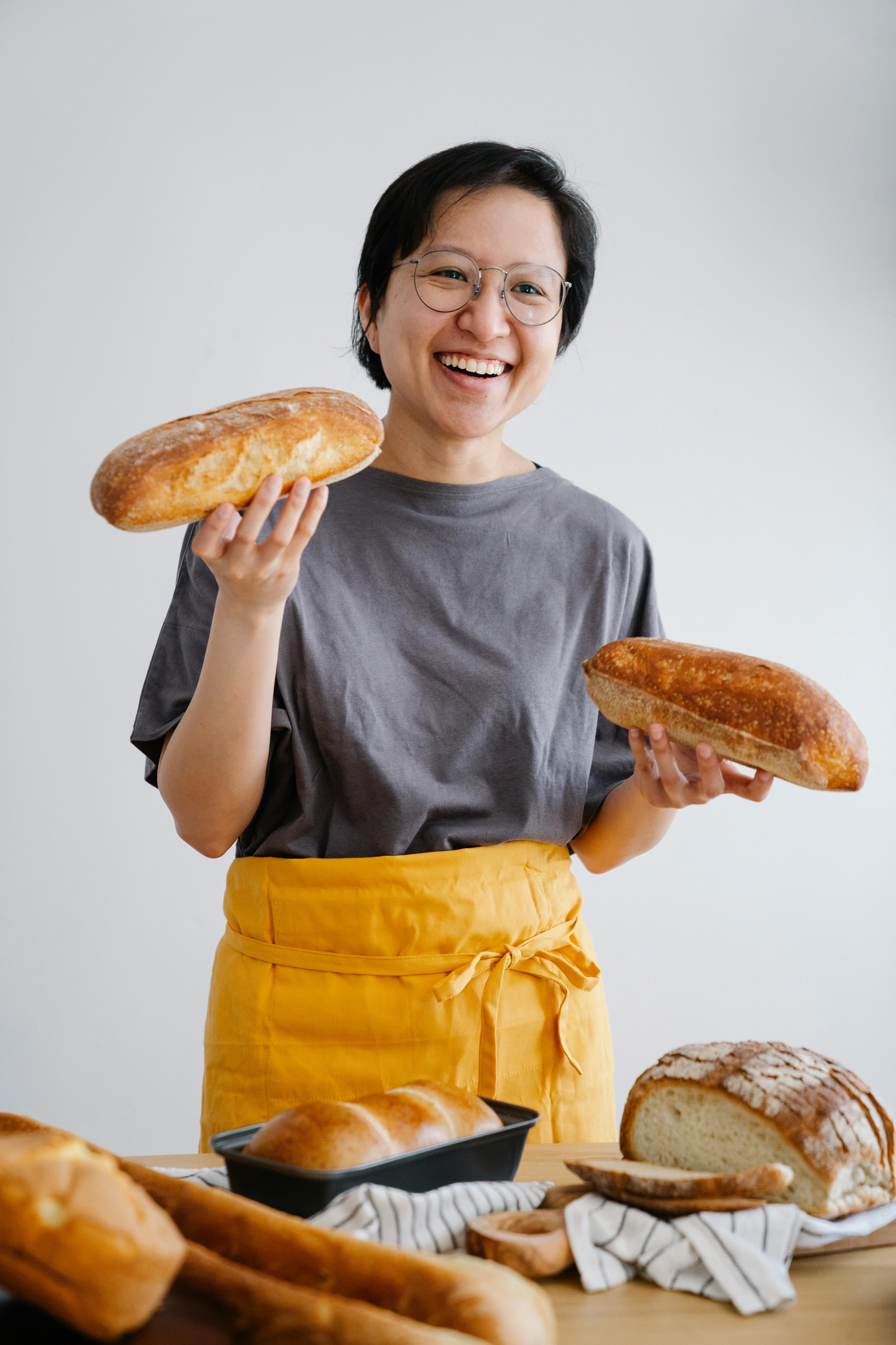 Smiling Woman with Breads · Free Stock Photo