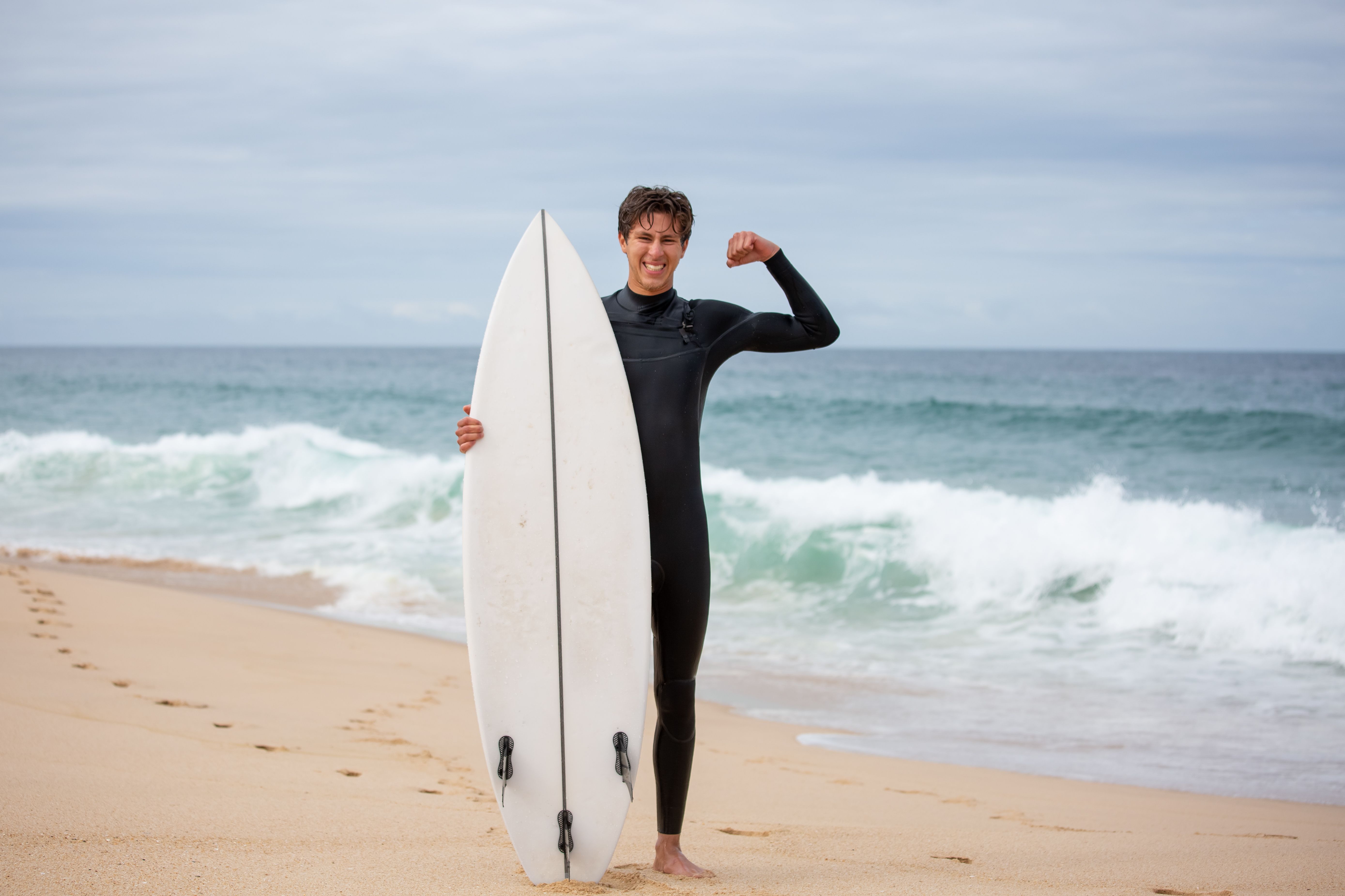 A Man Posing with His White Surfboard · Free Stock Photo