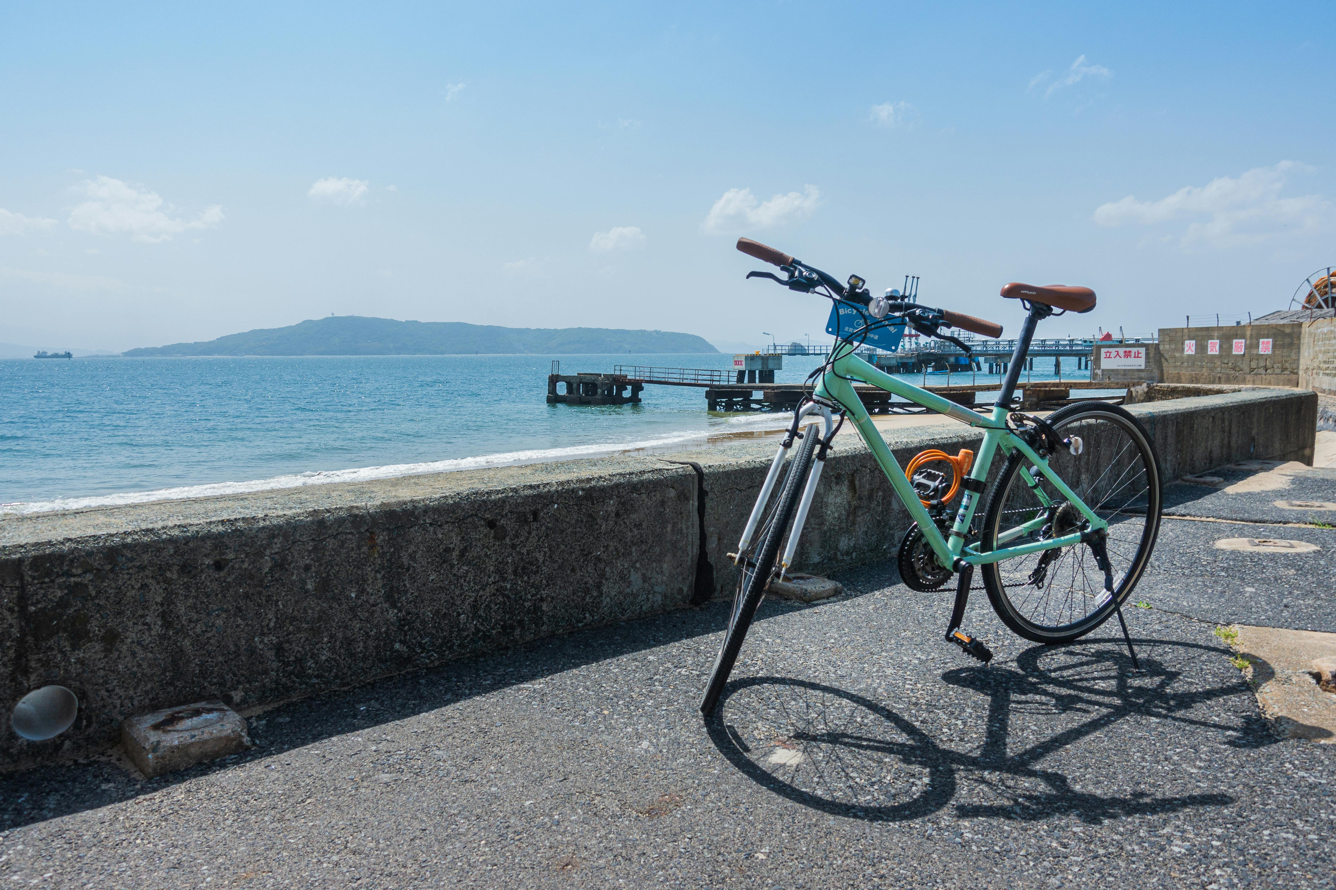 A Bicycle Parked by the Seawall · Free Stock Photo