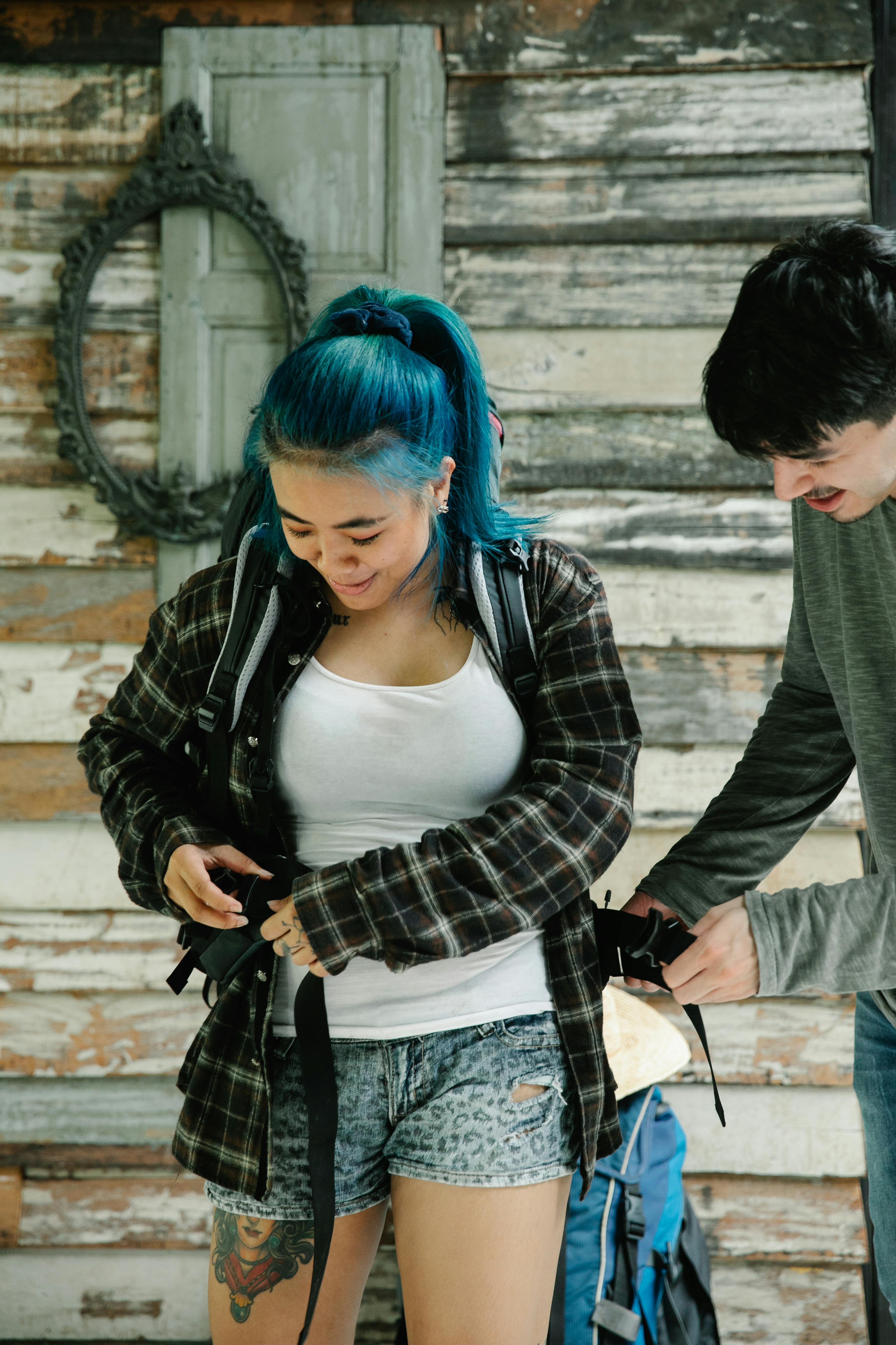 Boyfriend helping girlfriend with backpack · Free Stock Photo