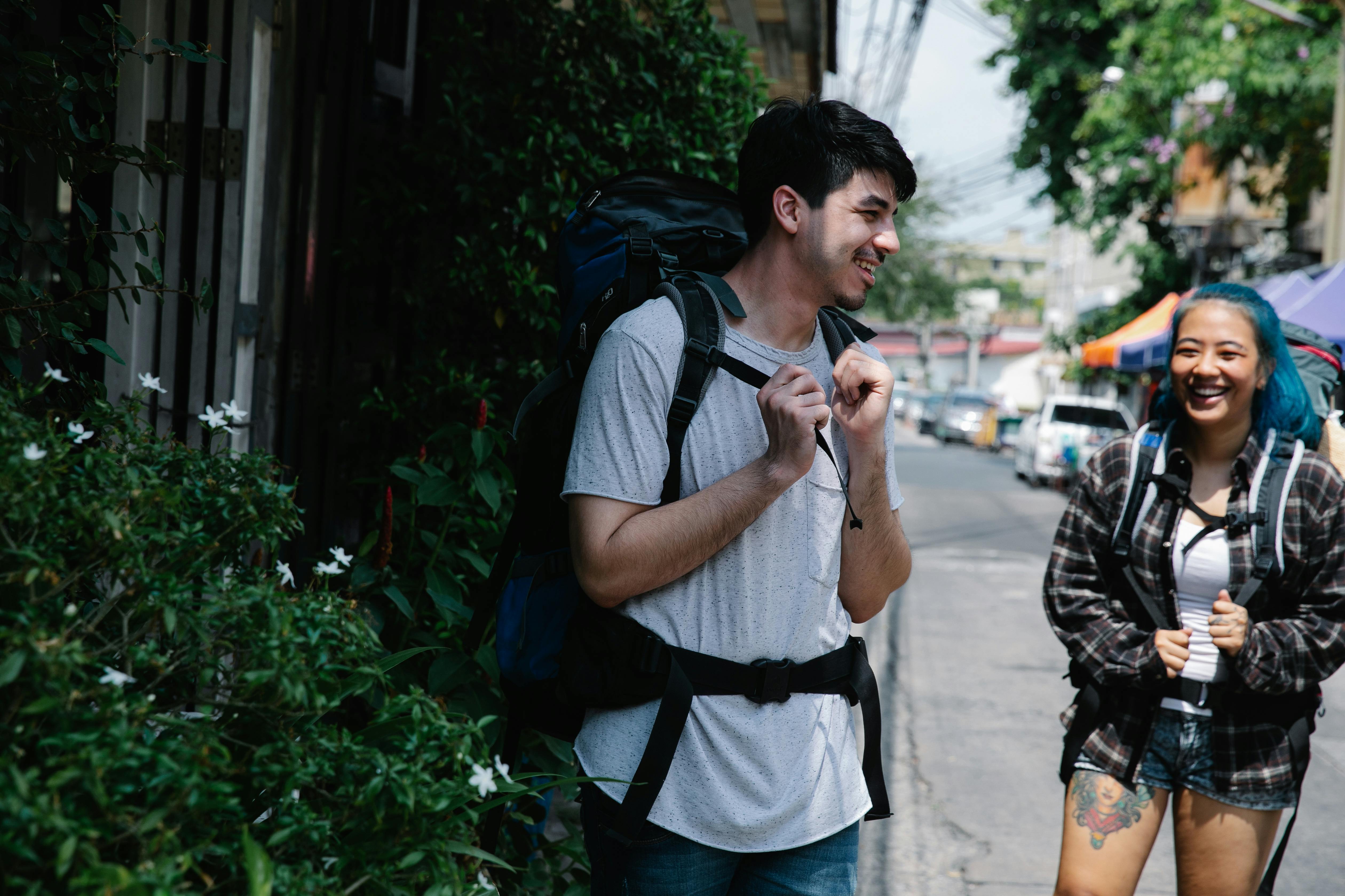 Smiling Backpackers on Street · Free Stock Photo