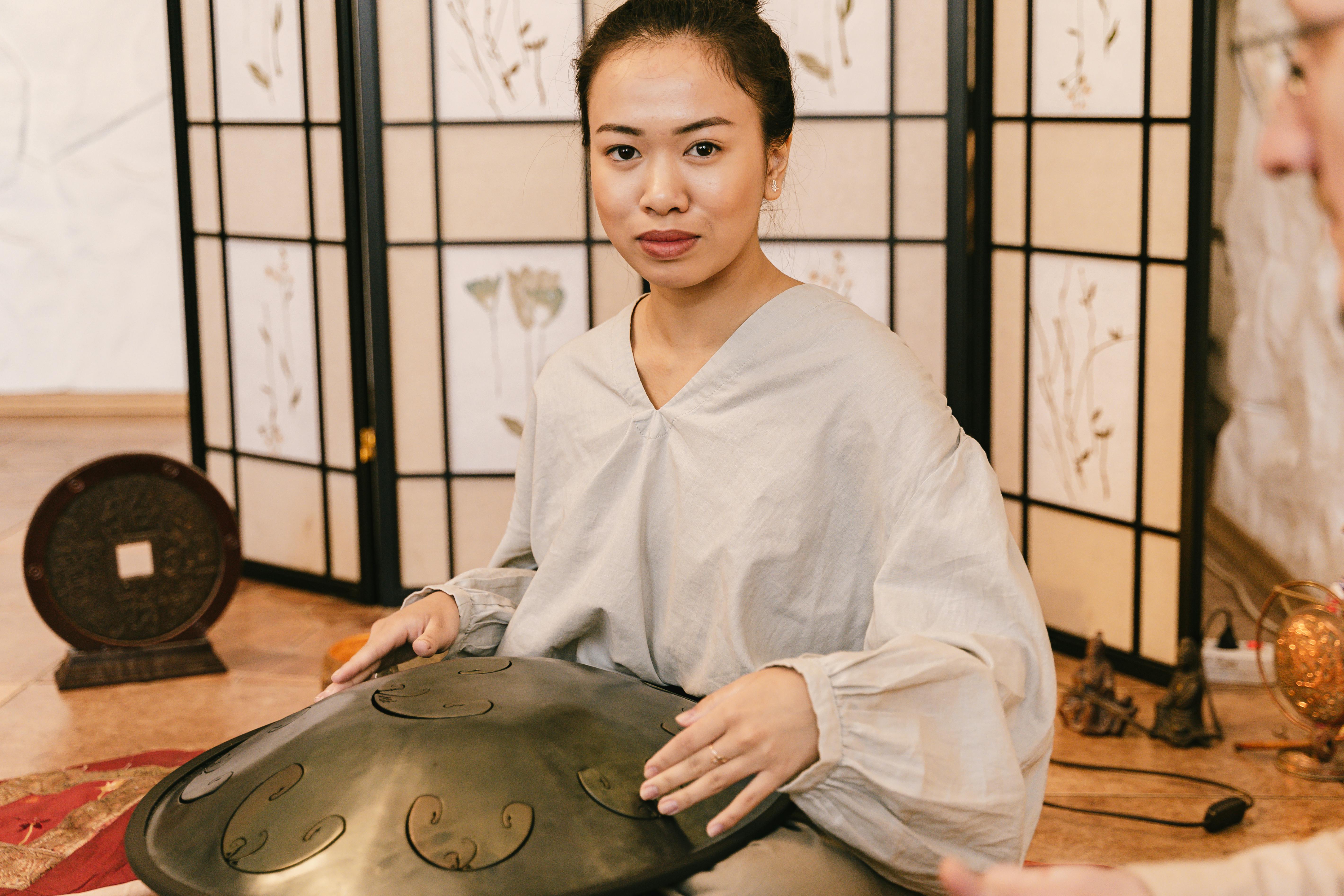 A Woman Using a Handpan · Free Stock Photo