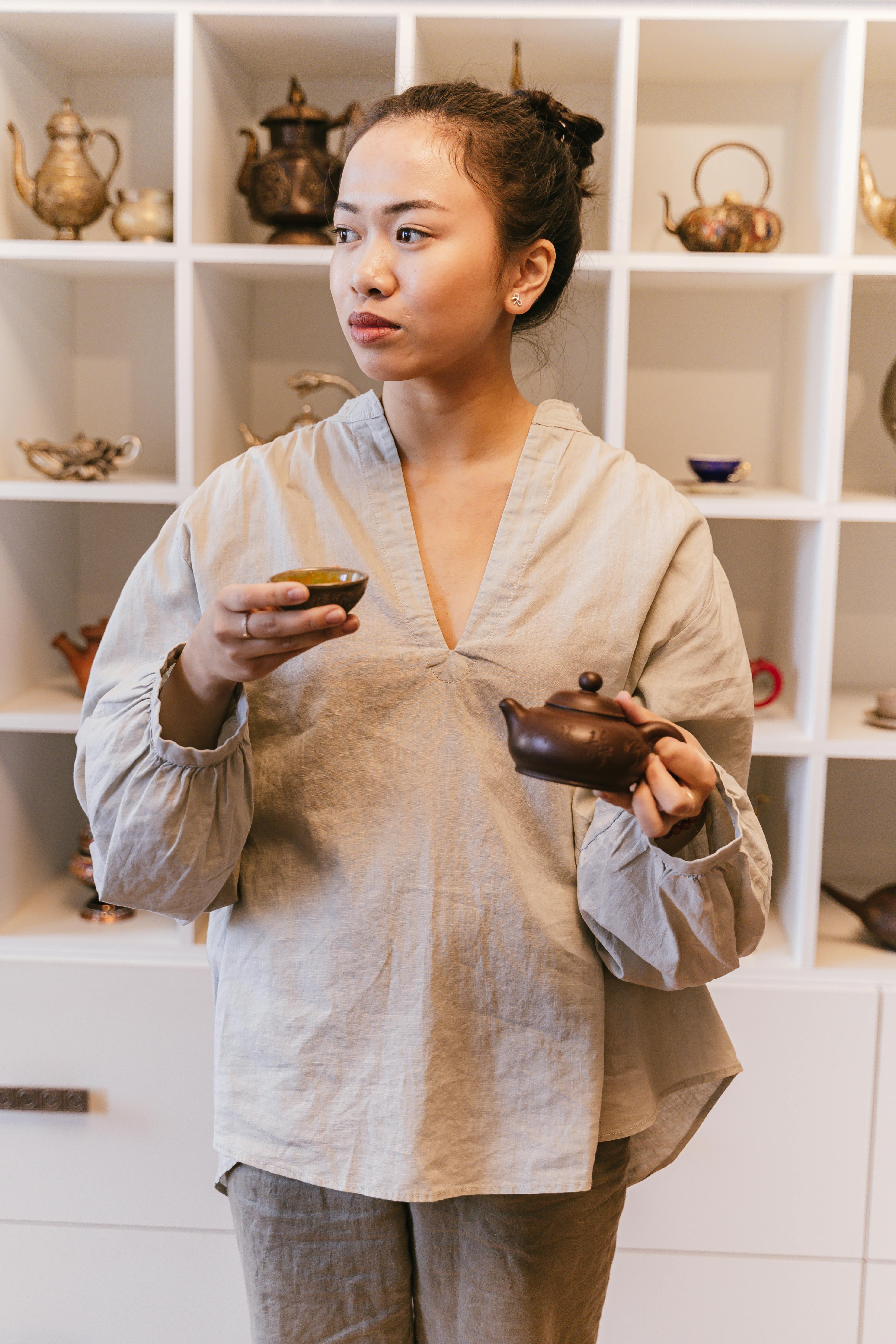 Woman Holding Teapot and Tea Cup · Free Stock Photo