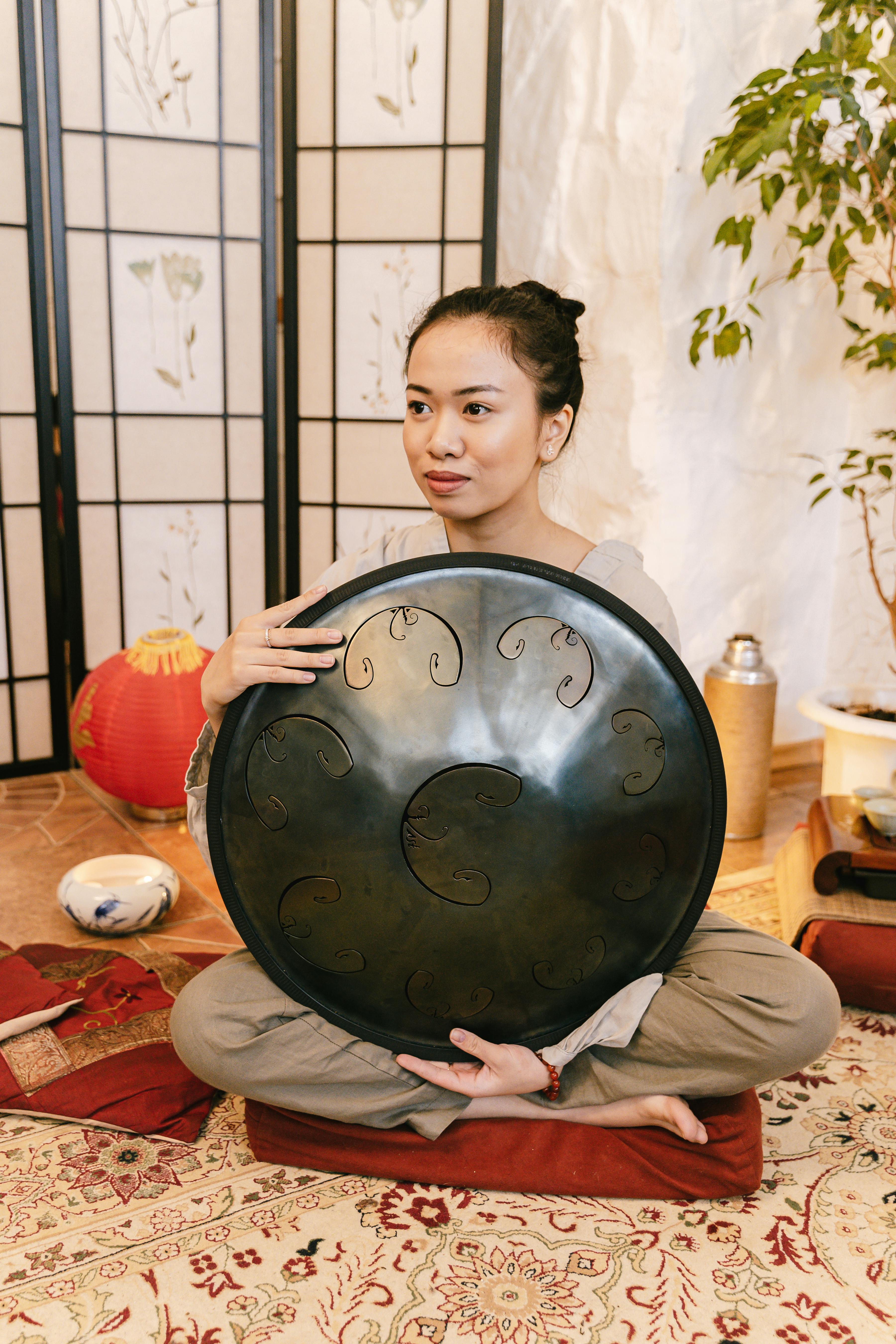 A Woman Holding a Handpan · Free Stock Photo