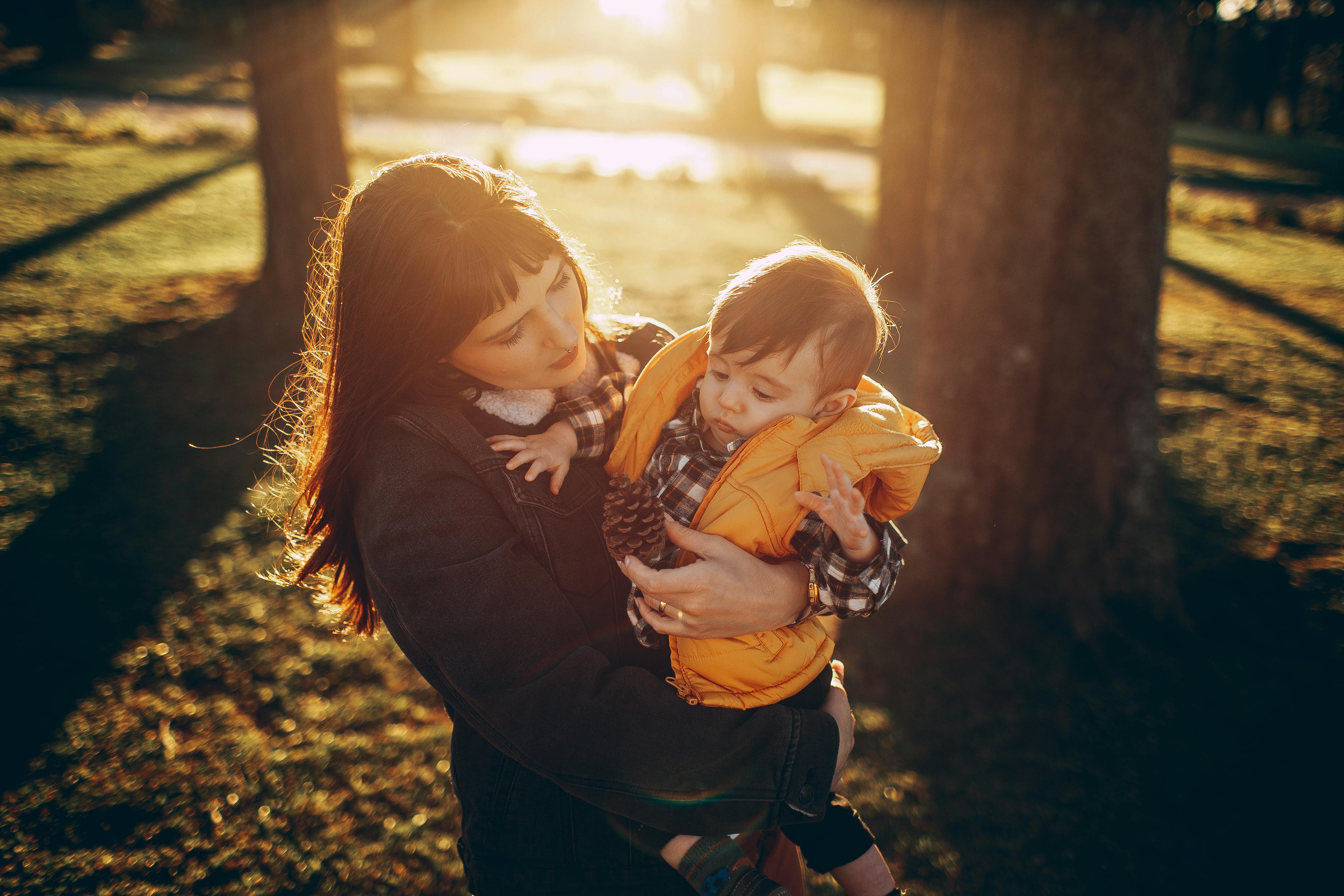 A Mother Carrying Her Son · Free Stock Photo