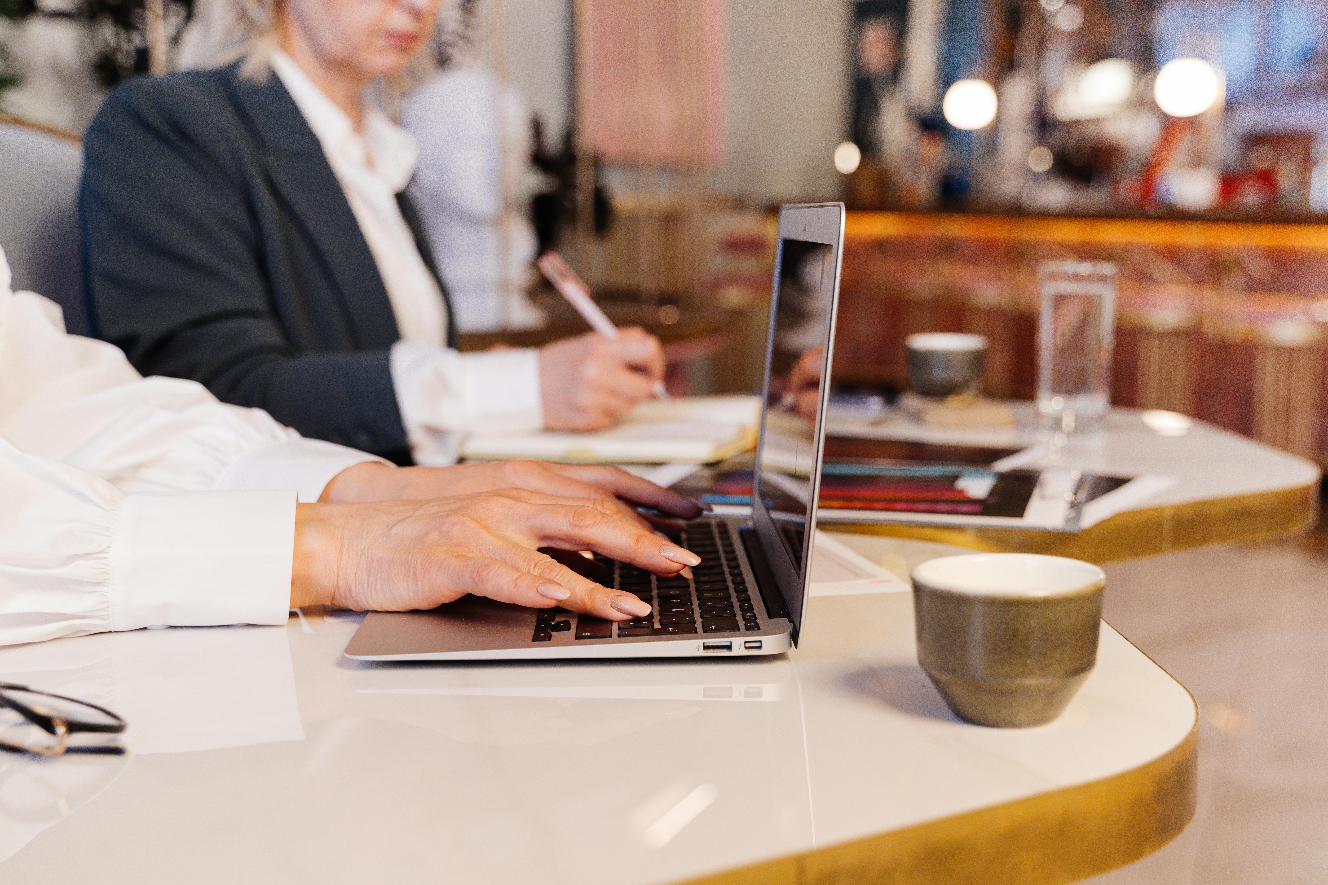 Photo of a Woman with Manicured Nails Typing on a Laptop Keyboard ...