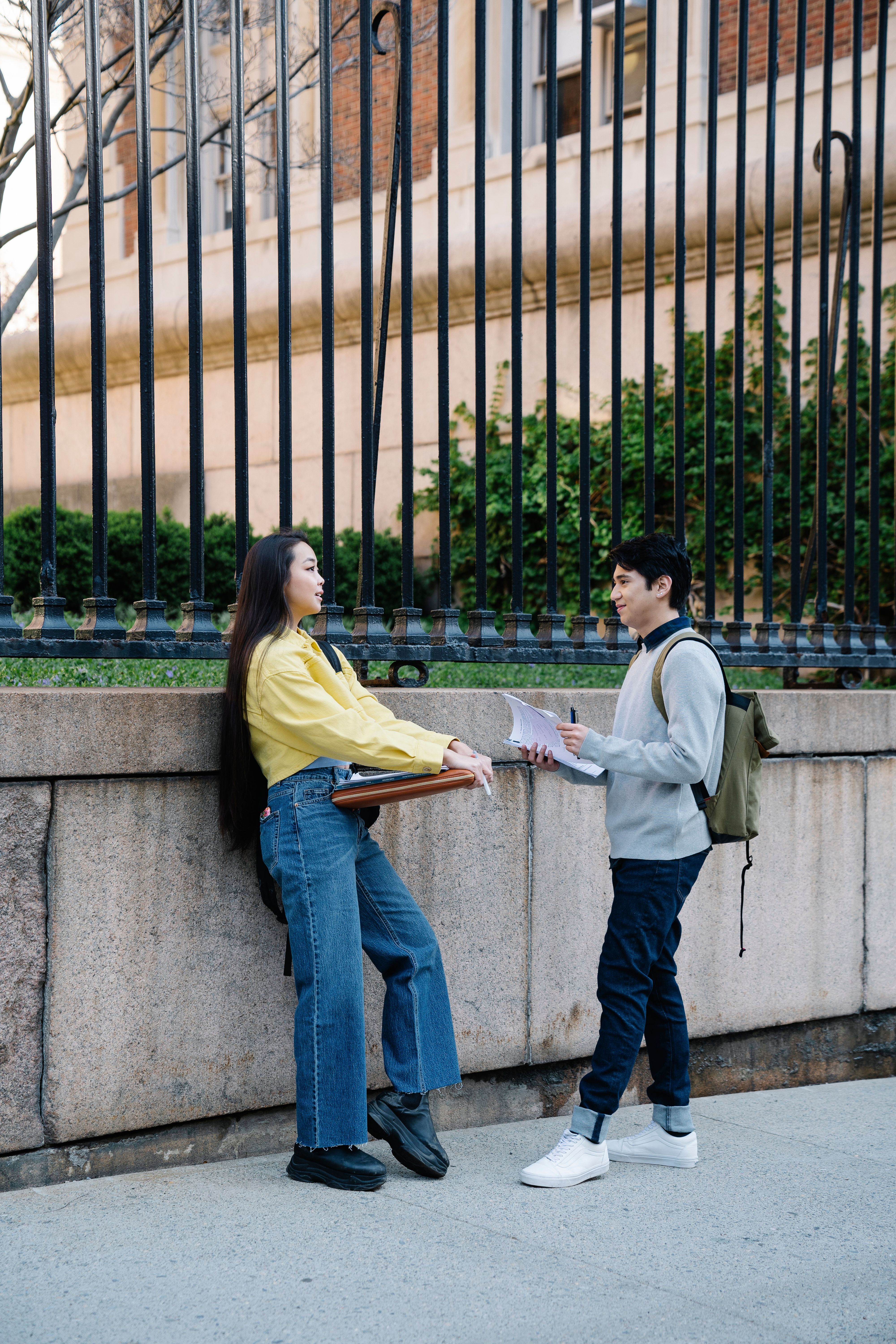 Two Friends Standing Together while Talking · Free Stock Photo
