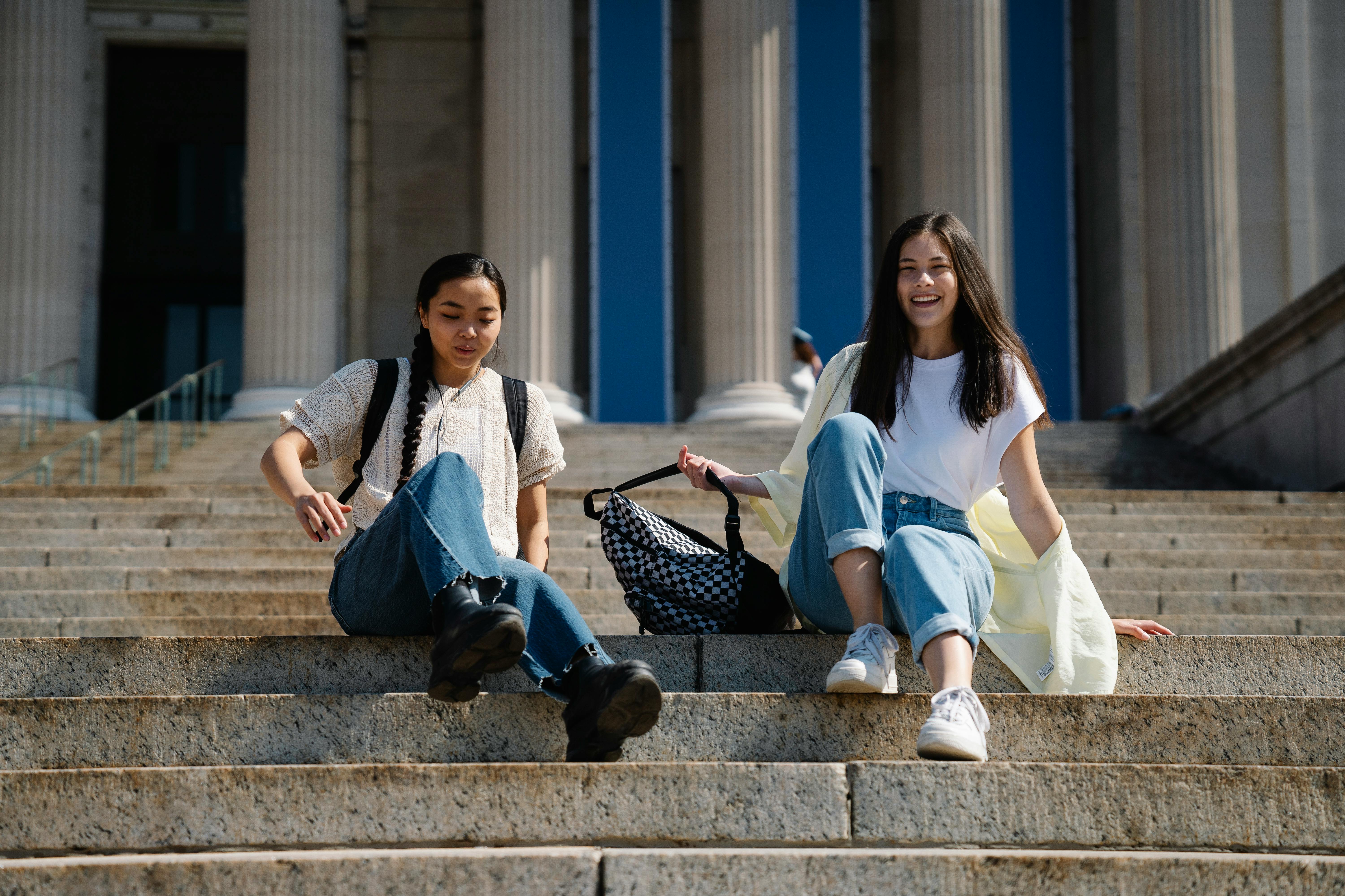 Two Women Sitting on a Staircase · Free Stock Photo