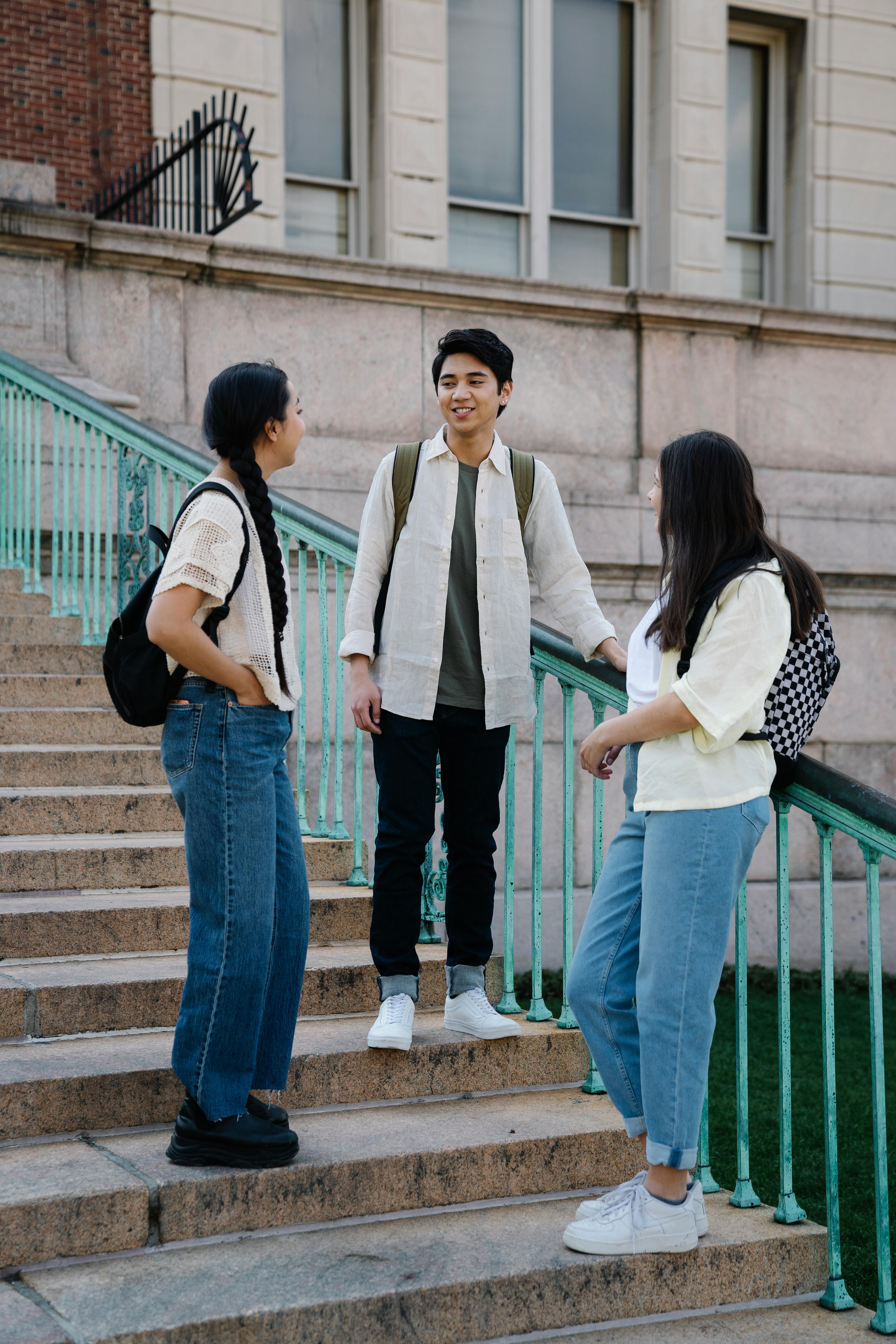 Three People Talking on the Stairs · Free Stock Photo