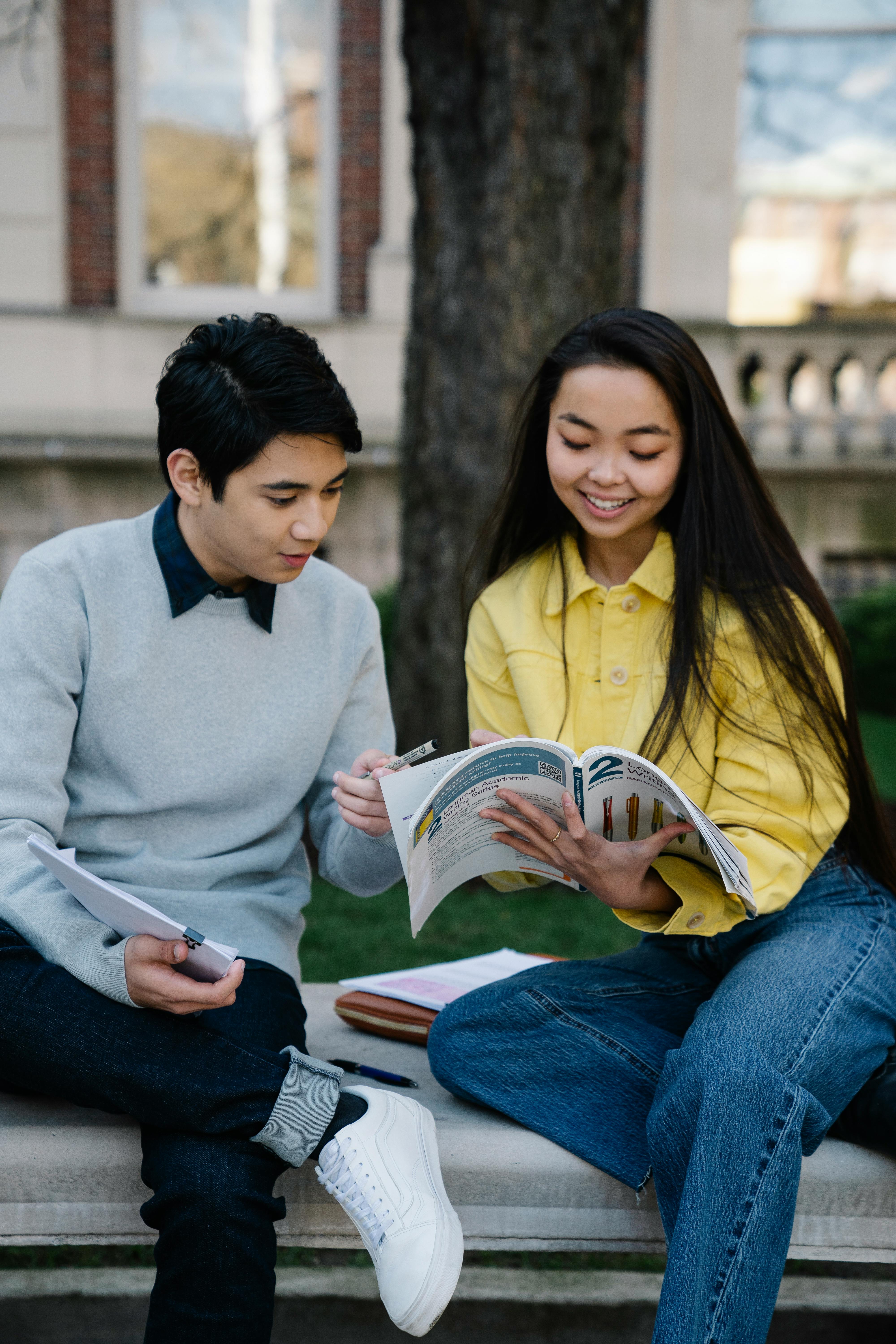 Smiling Woman and Man with Book · Free Stock Photo
