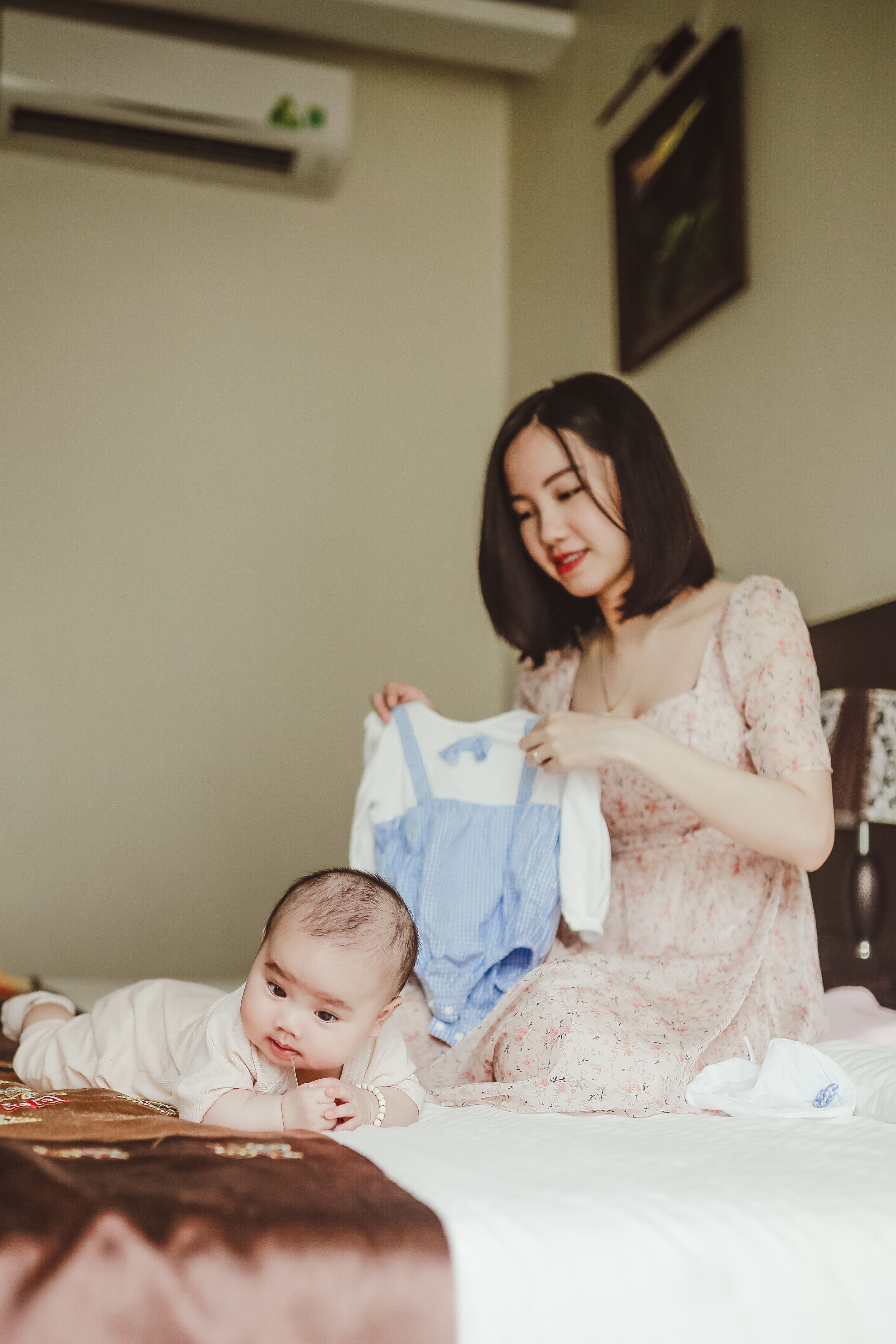 Woman Changing Baby's Clothes · Free Stock Photo