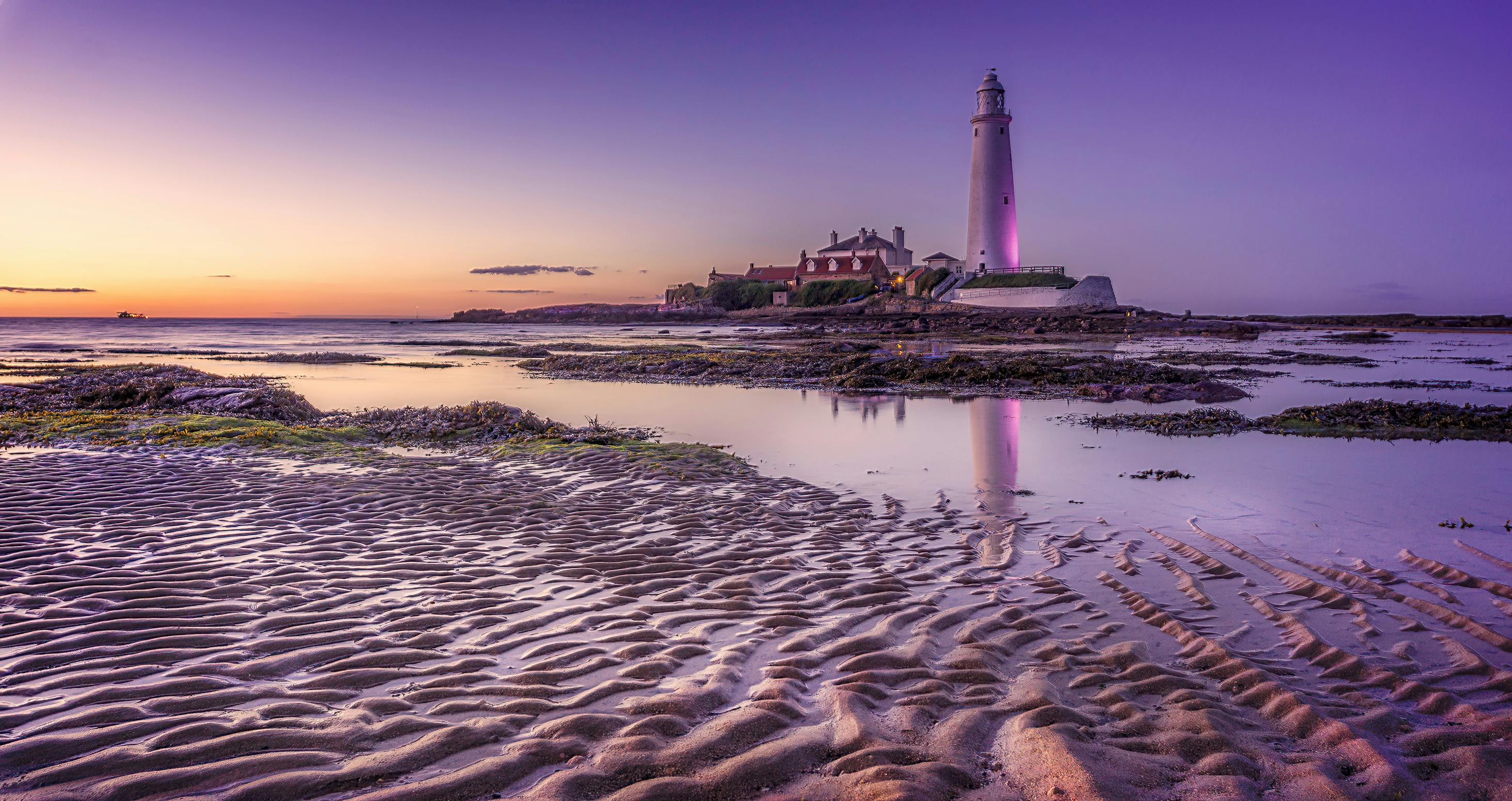 A White Lighthouse on the Beach during Sunset · Free Stock Photo