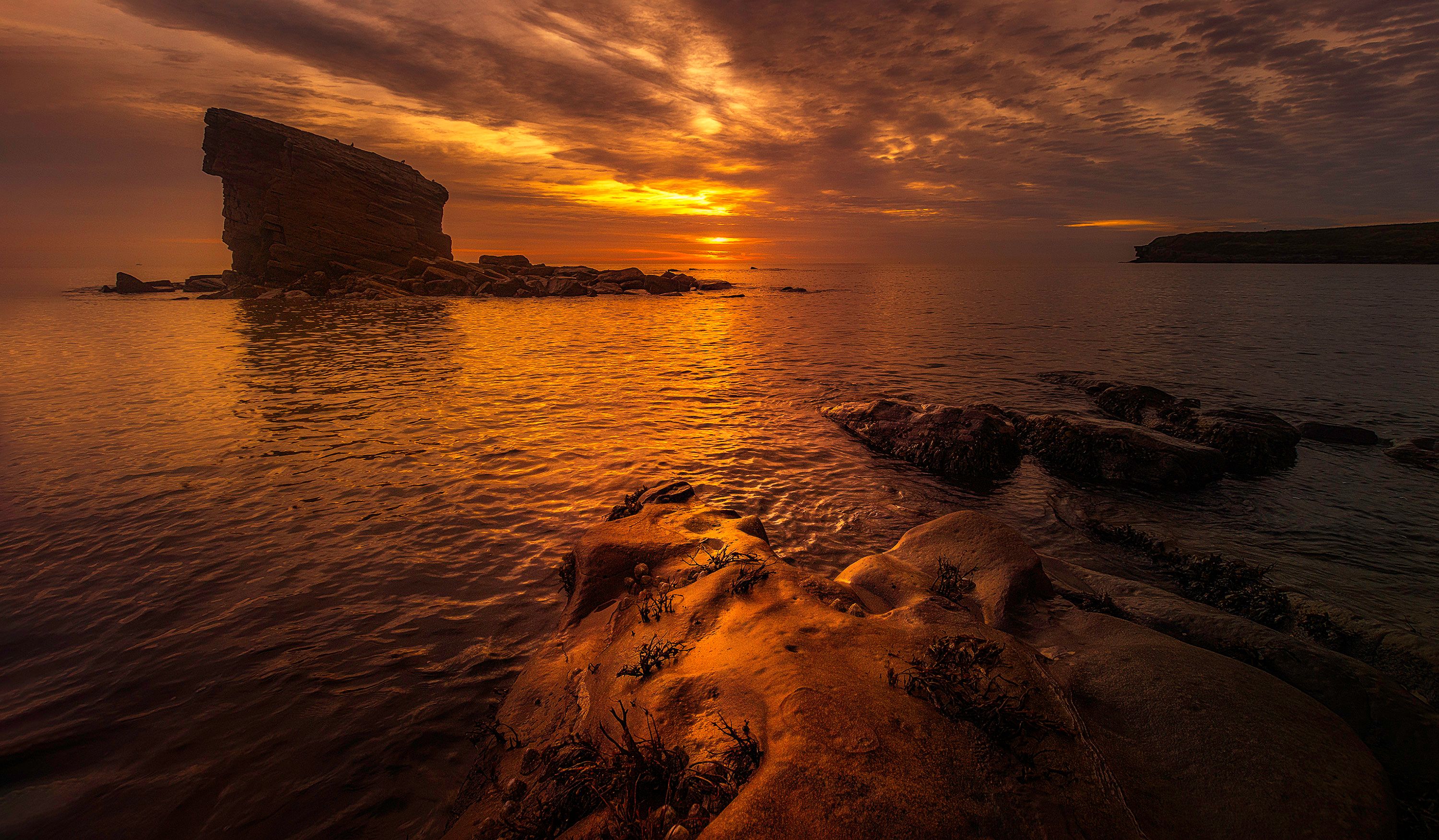 Rock Formations in the Ocean during Twilight · Free Stock Photo