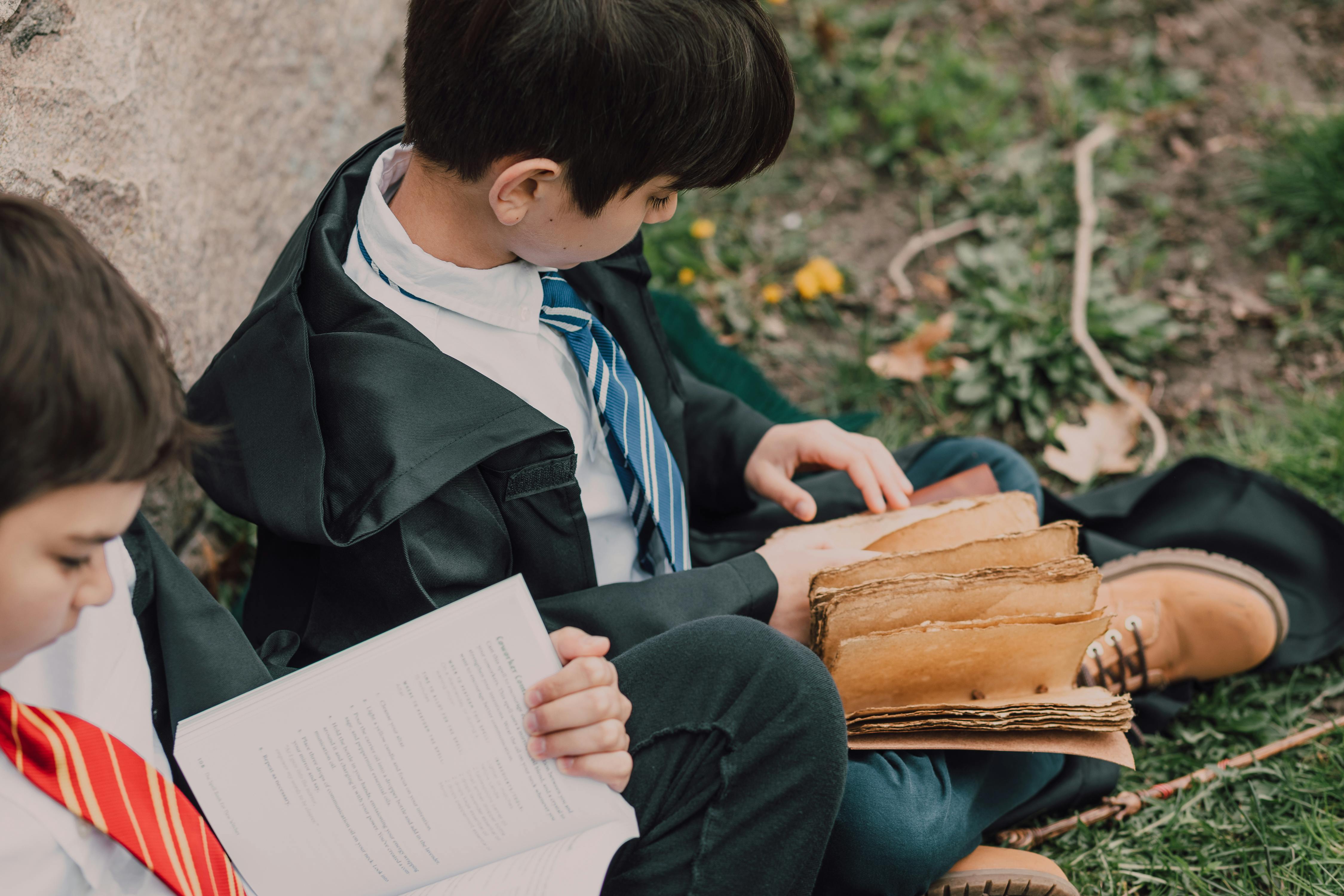 Boys in Black Robes Reading a Spell Book · Free Stock Photo