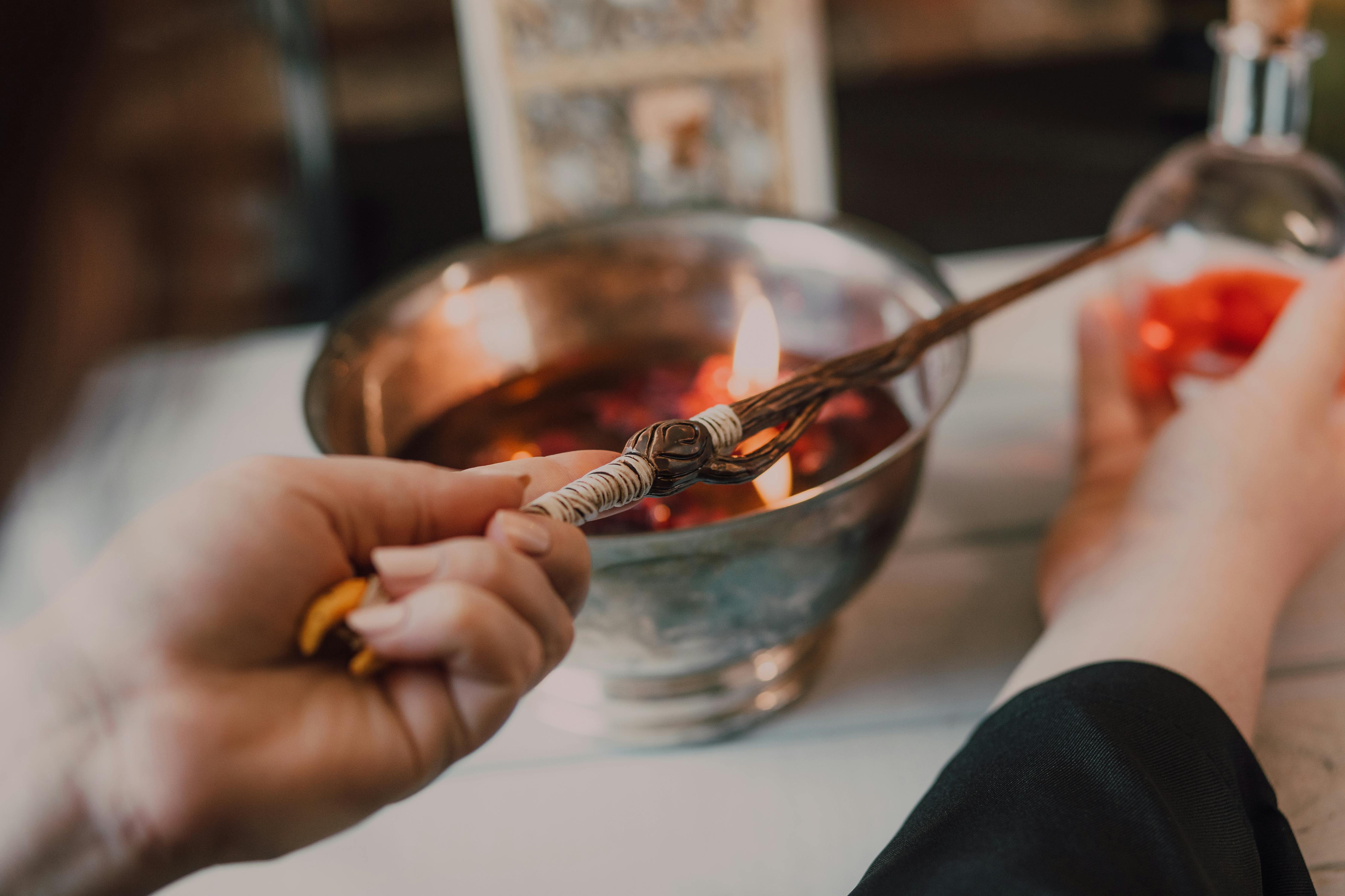 Close-Up Shot of a Wand beside a Spell book · Free Stock Photo