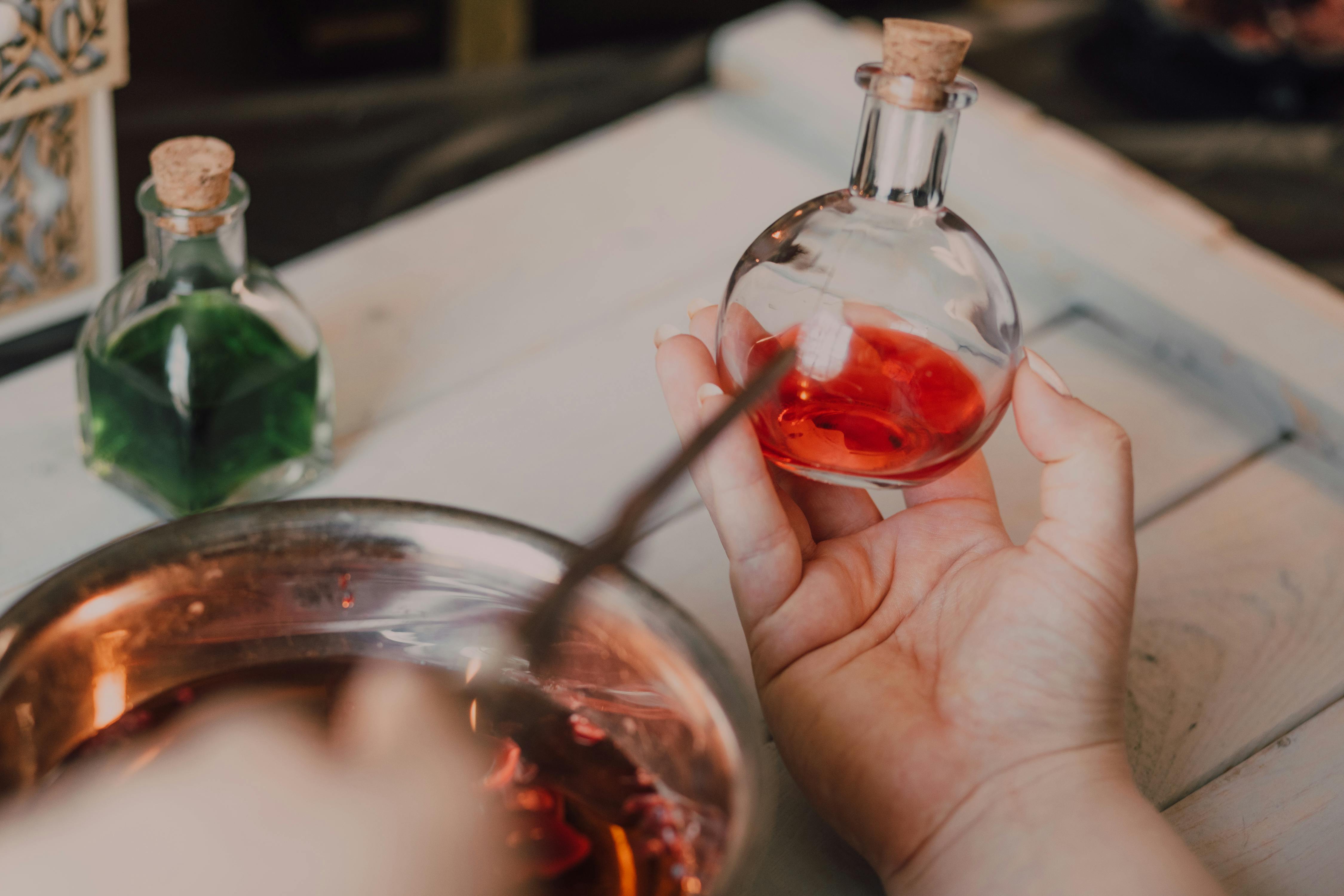 Close-Up Shot of a Person Holding a Potion · Free Stock Photo