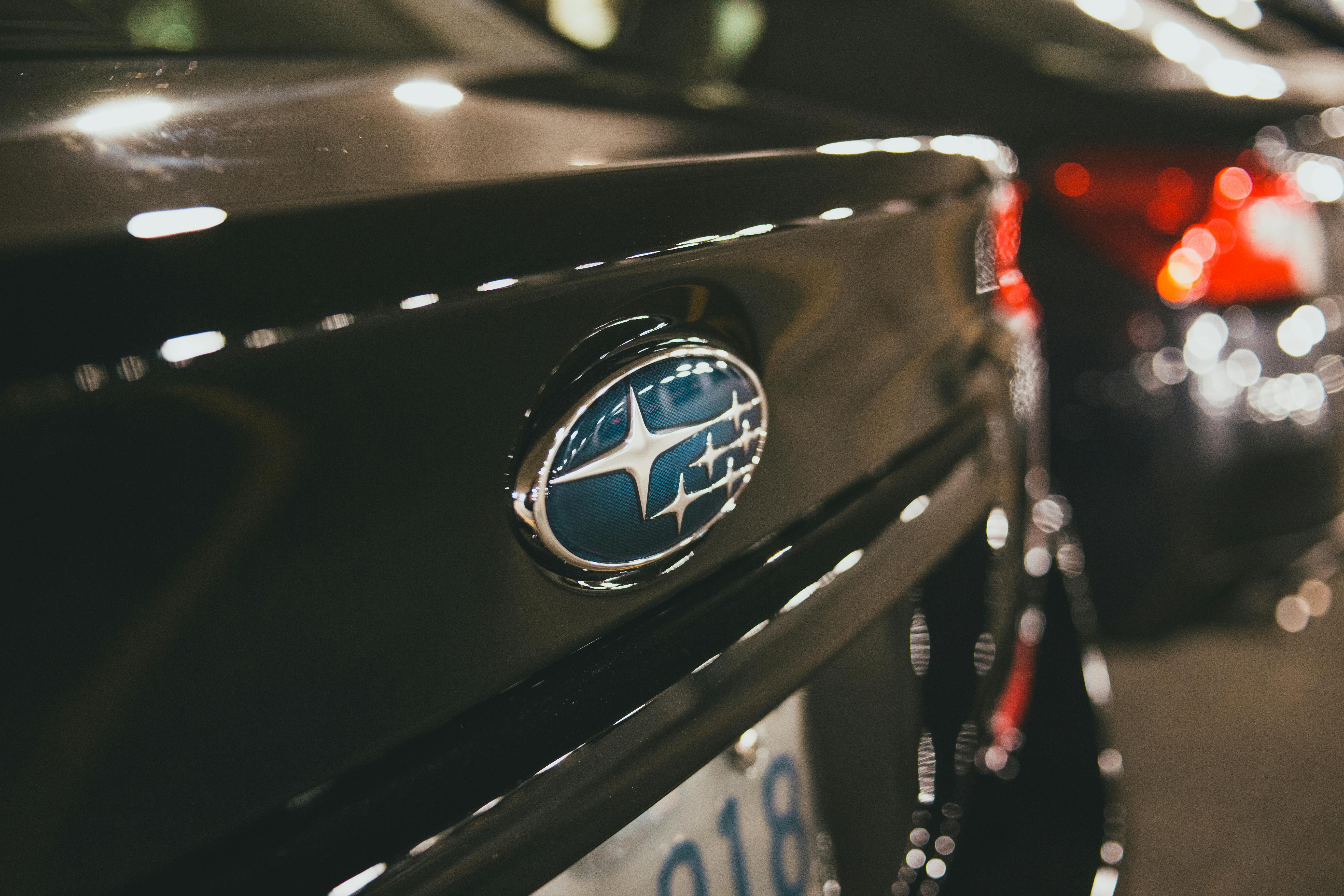 Subaru Emblem on Black Surface · Free Stock Photo