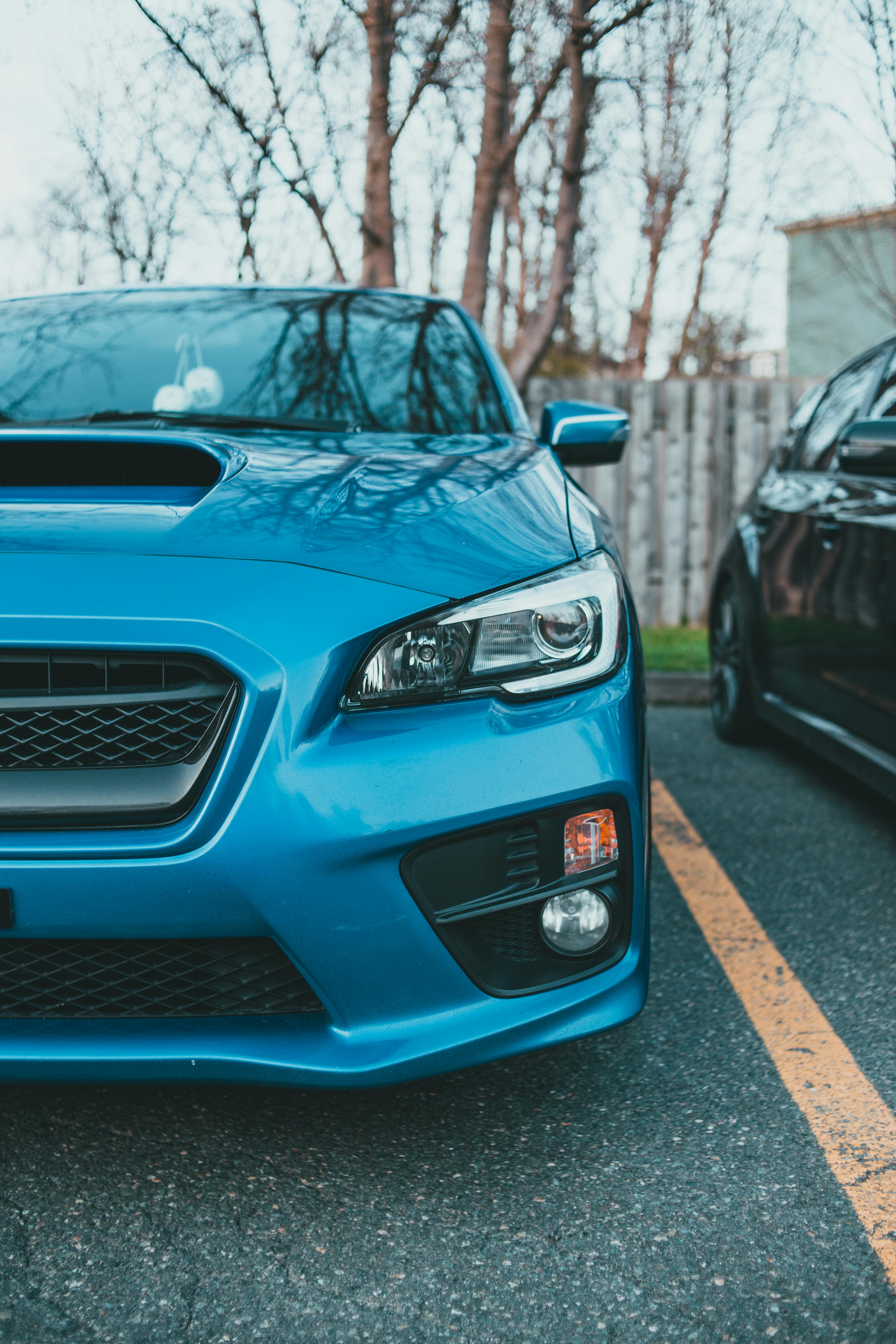 Blue Car Parked on an Asphalt Road · Free Stock Photo