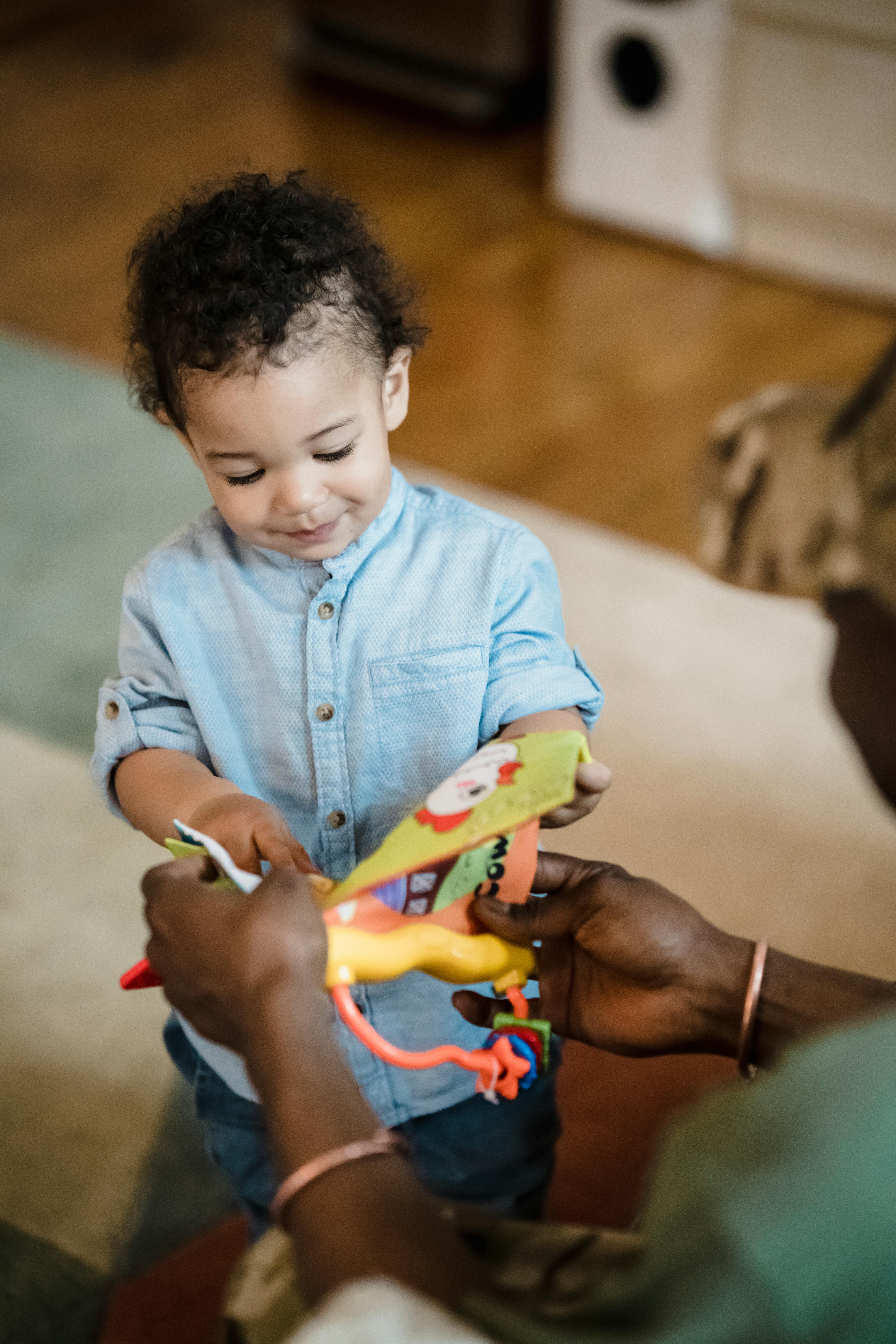 Father Handing a Toy to his Little Son · Free Stock Photo