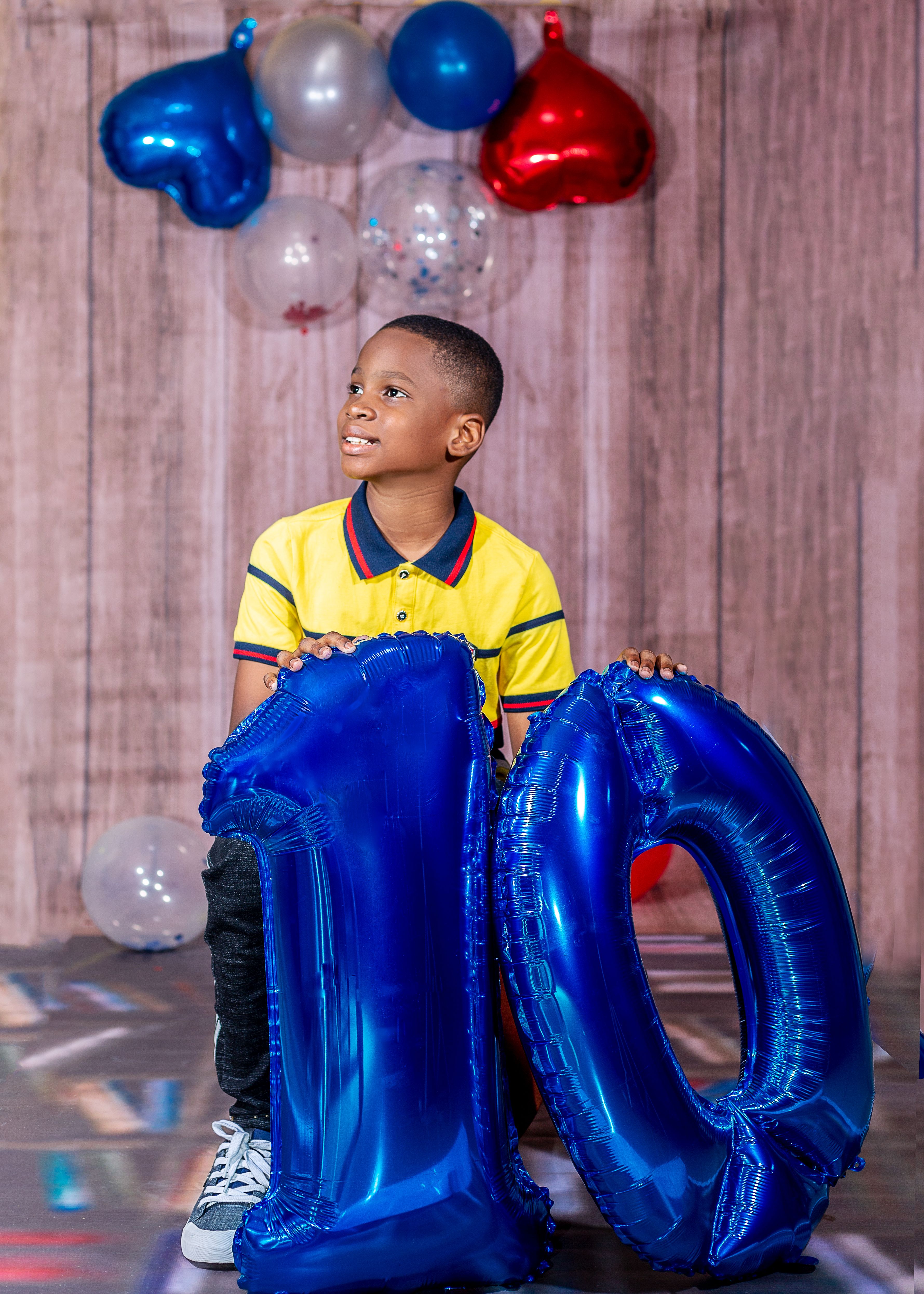 A Boy Holding Blue Balloons · Free Stock Photo