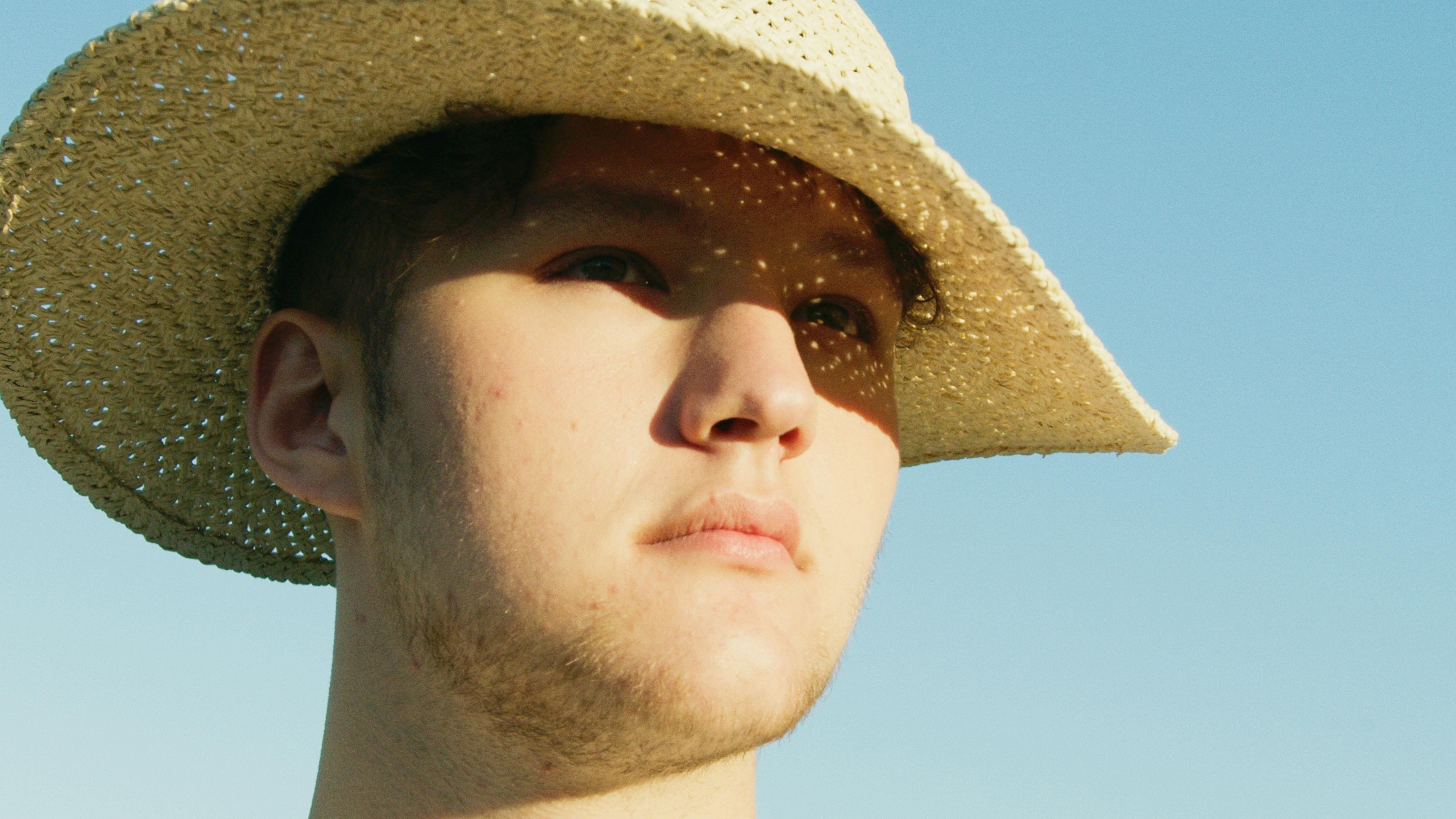 Man Wearing Straw Hat Looking Afar · Free Stock Photo