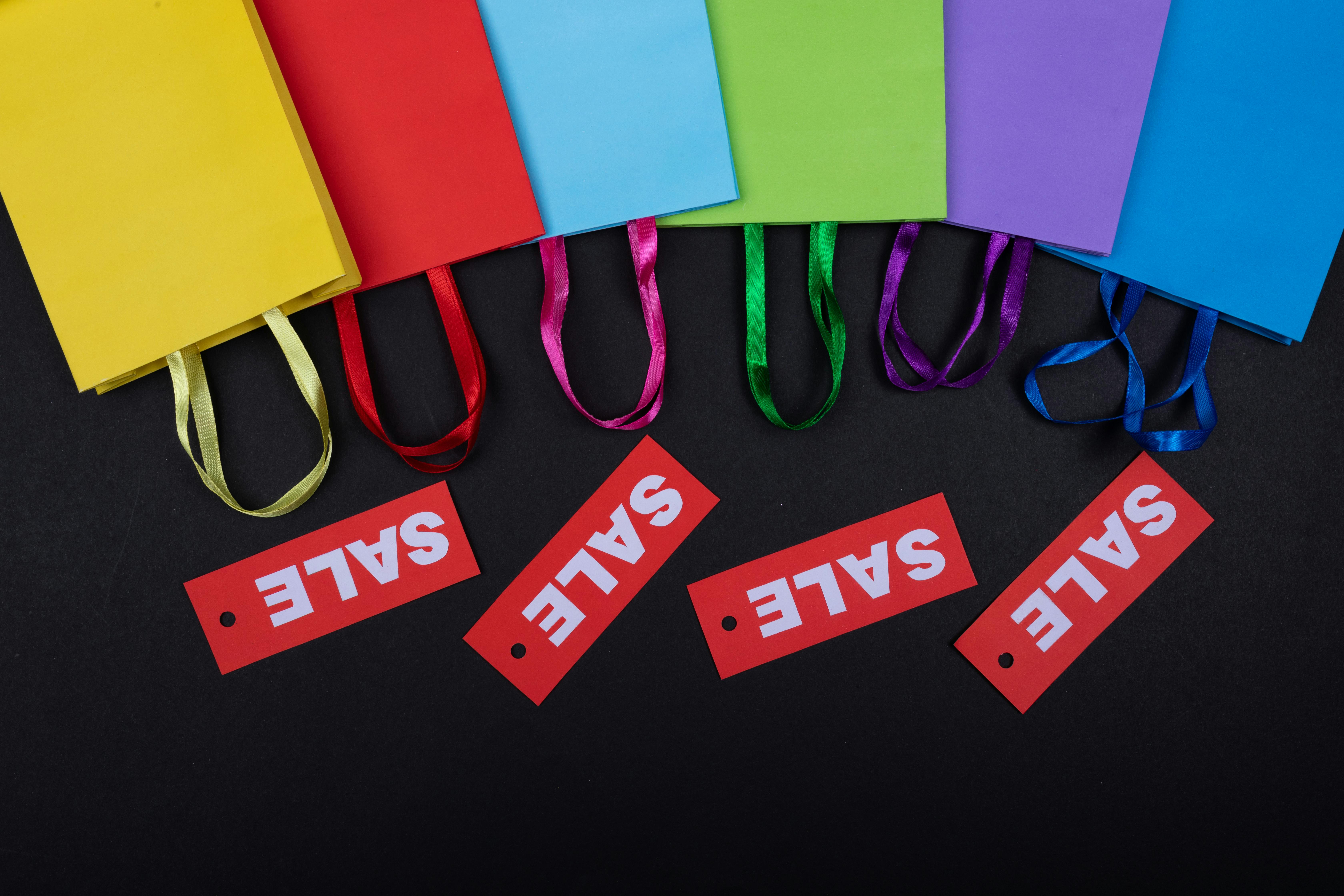 Red Tags with Colorful Paper Bags · Free Stock Photo