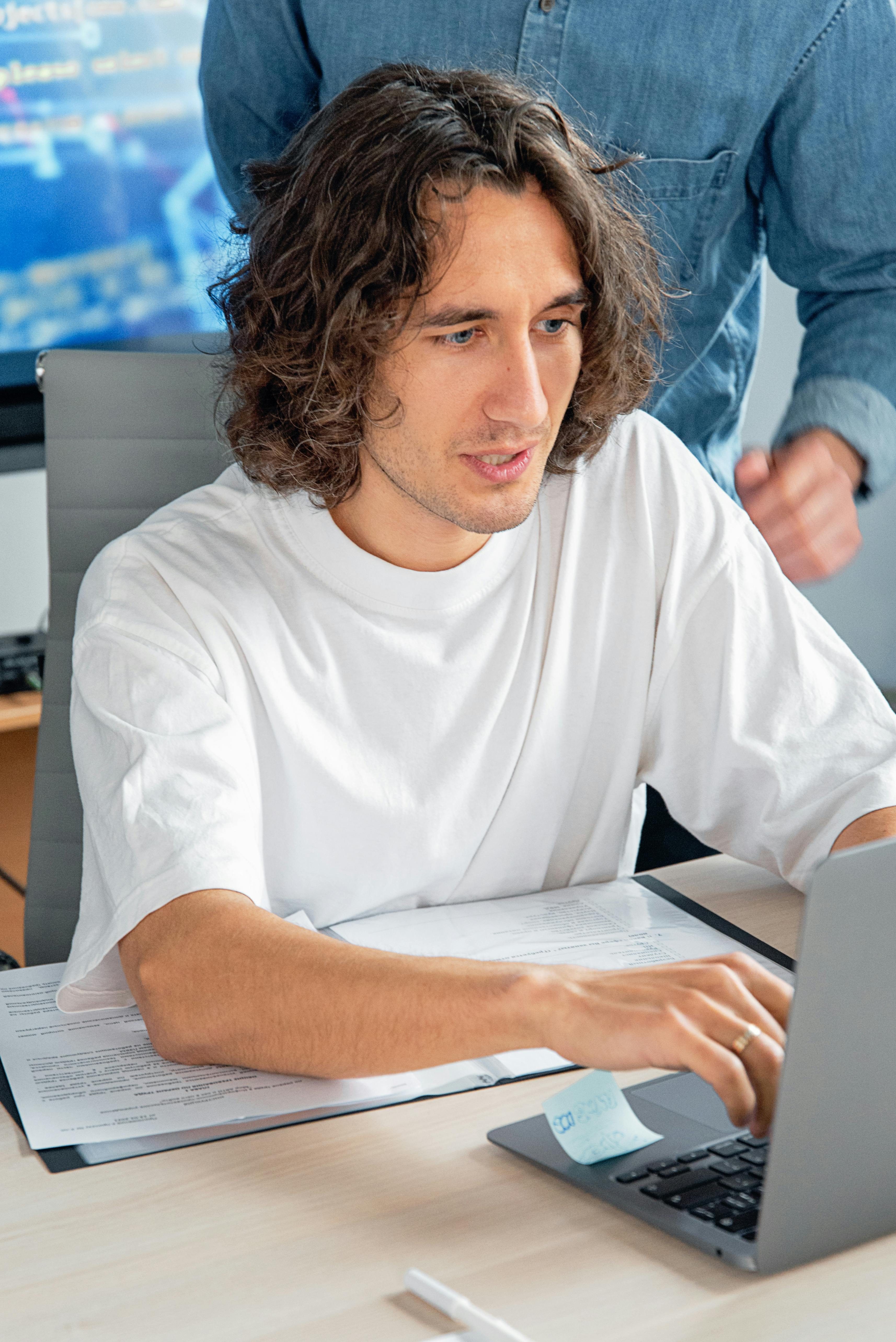 Man Typing on Laptop · Free Stock Photo