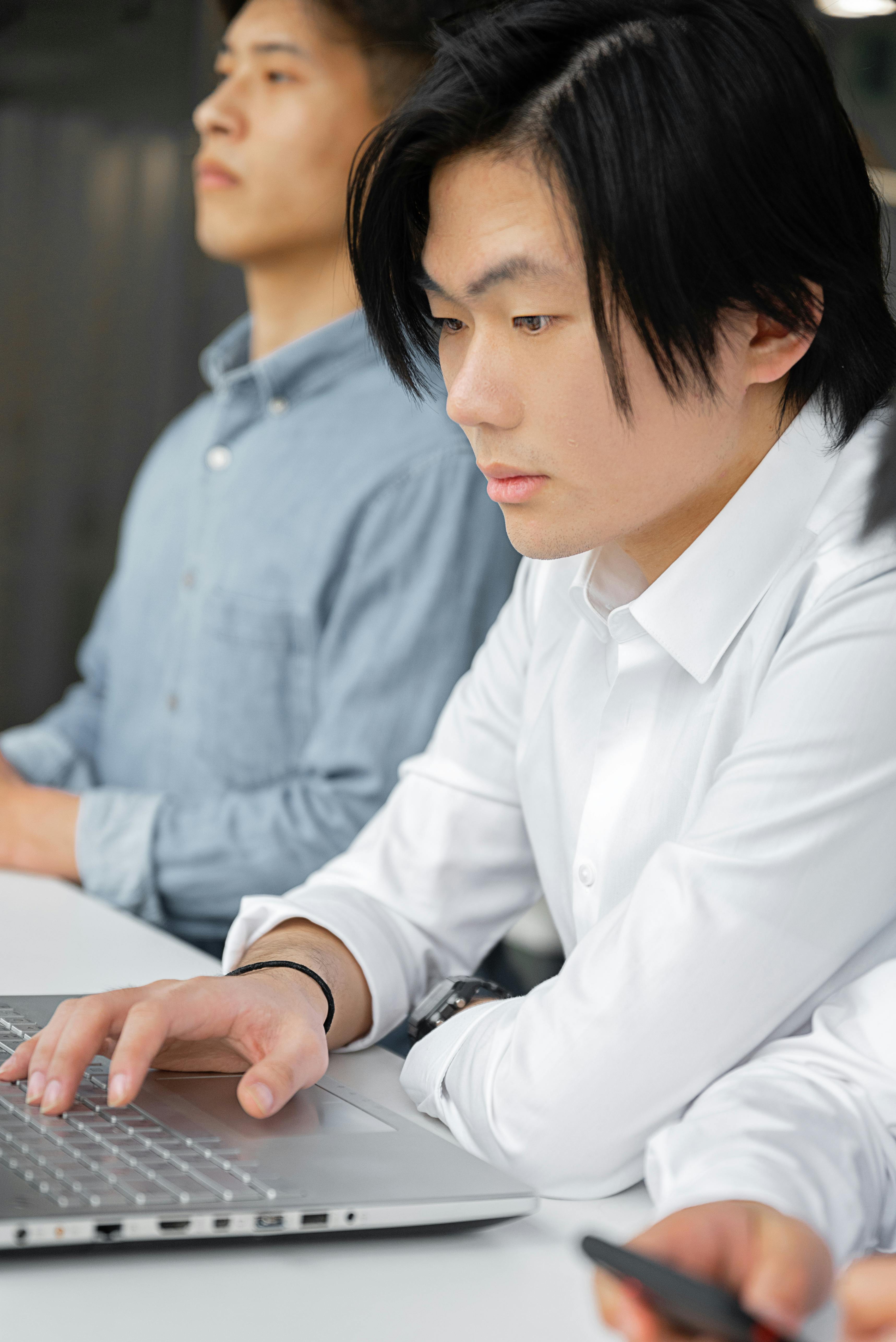 A Man Typing on Laptop · Free Stock Photo